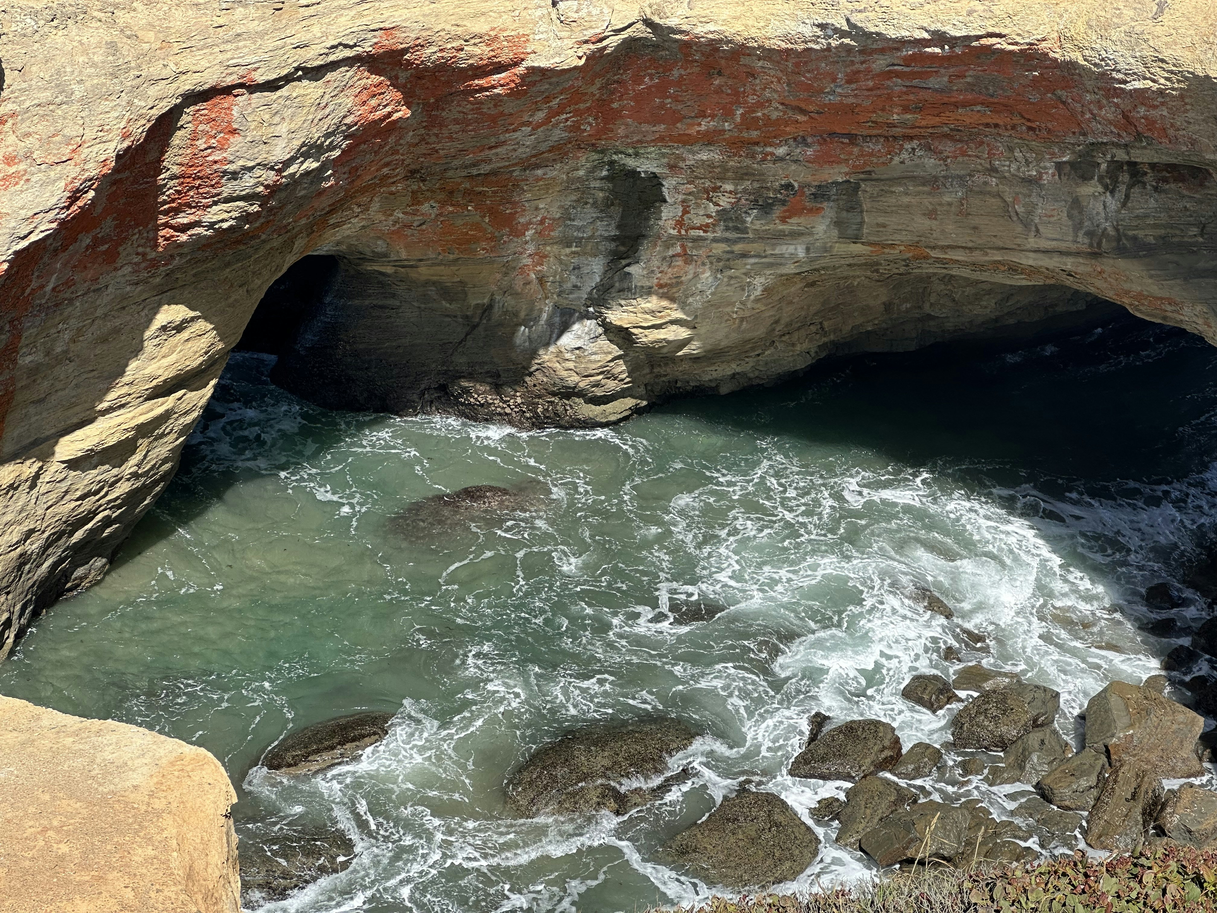 A cave with a body of water inside of it photo – Free Water Image on ...
