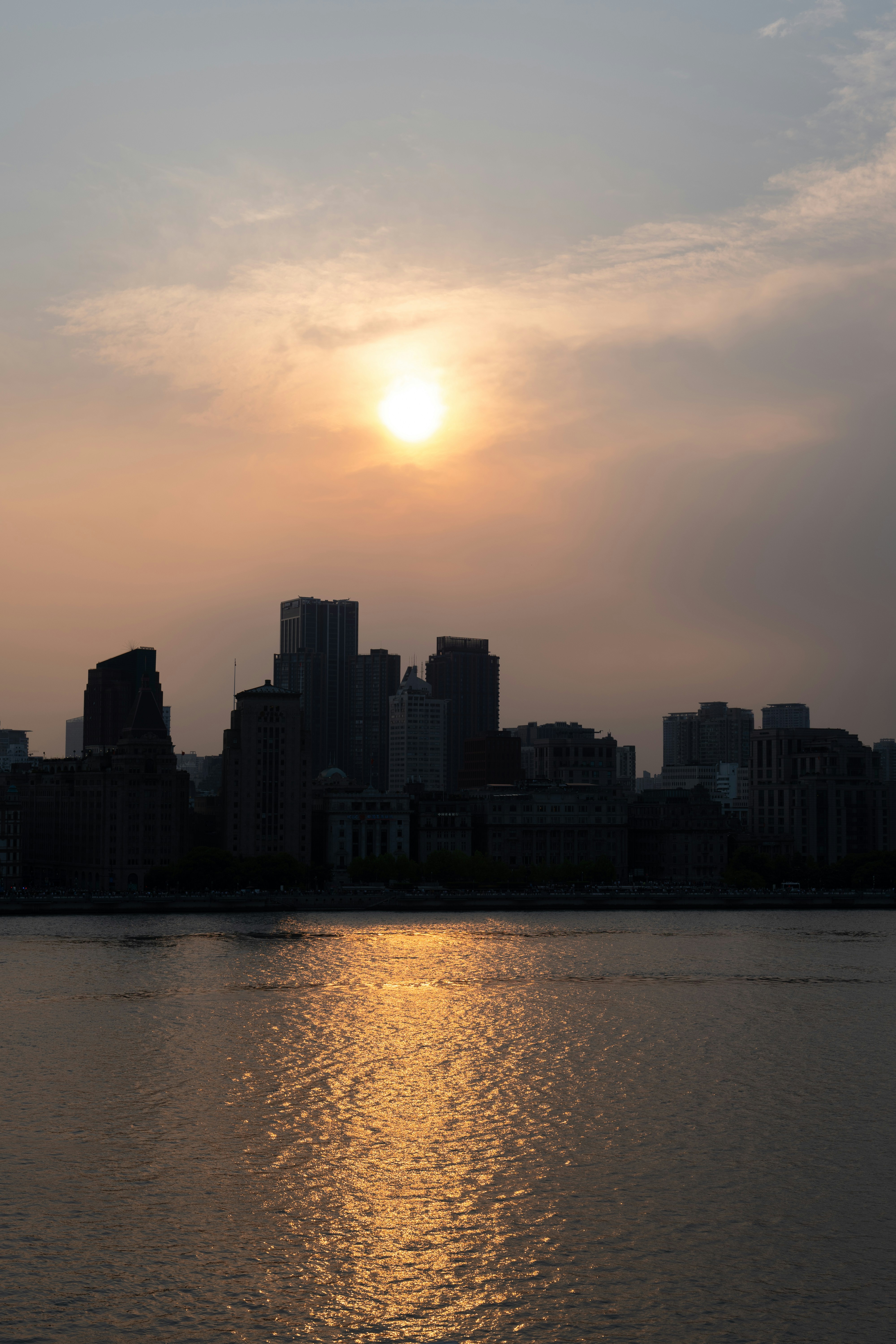Dawn over the Concrete Skyline: Golden Light Drapes a Quiet Waterfront