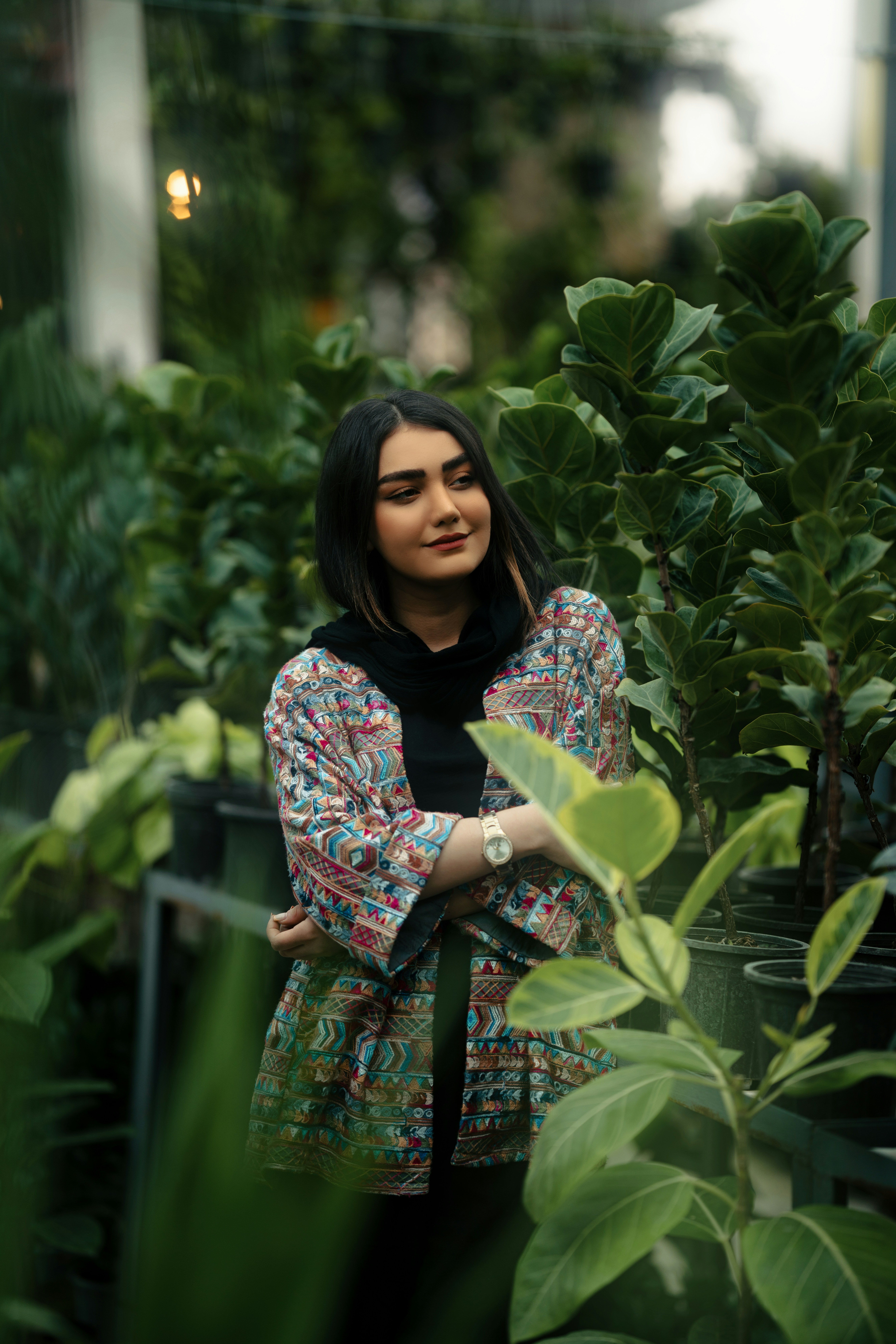 A woman standing in front of a bunch of plants photo – Free Girl Image on Unsplash