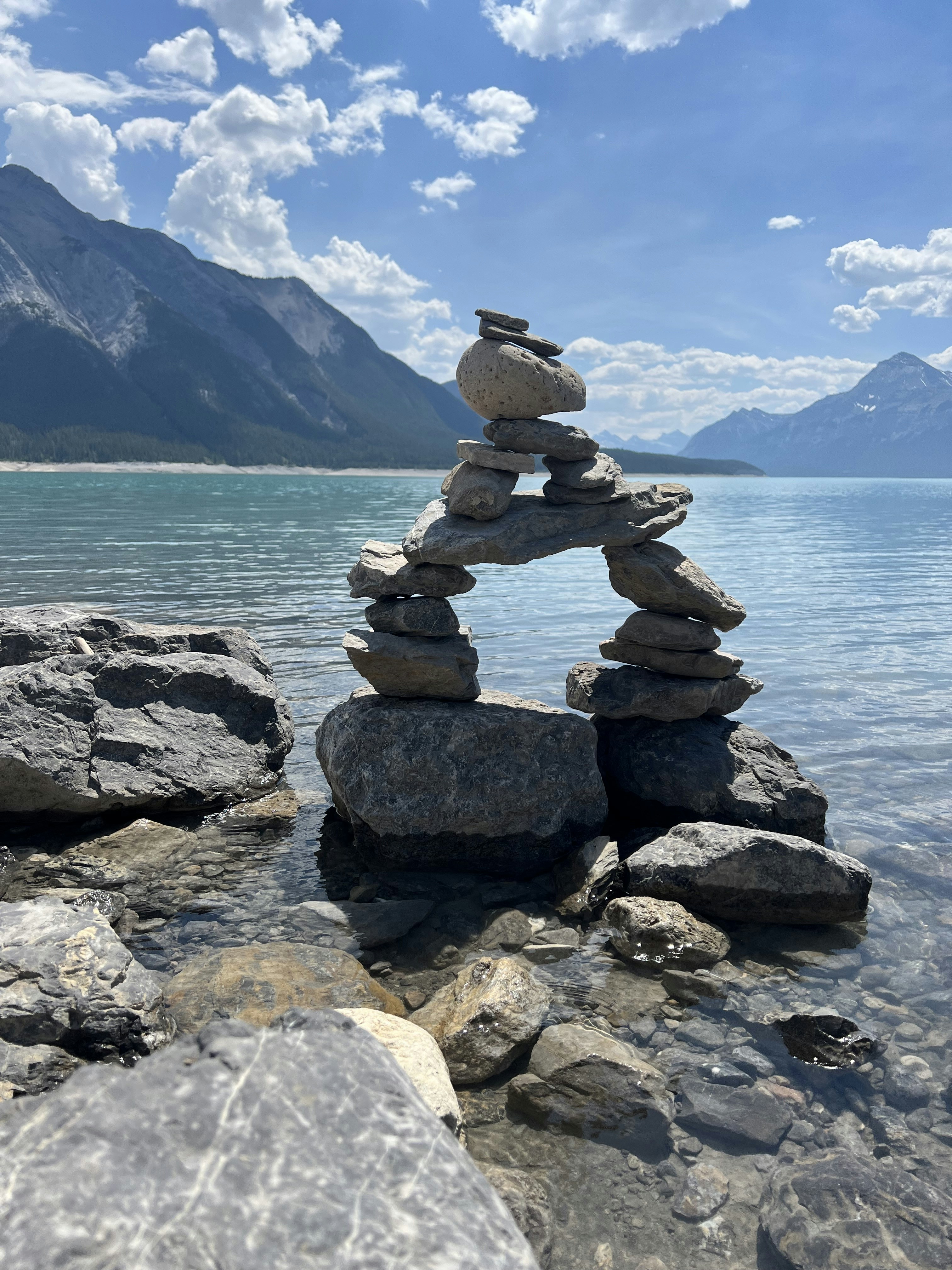A stack of rocks sitting on top of a lake photo – Free Clearwater ...