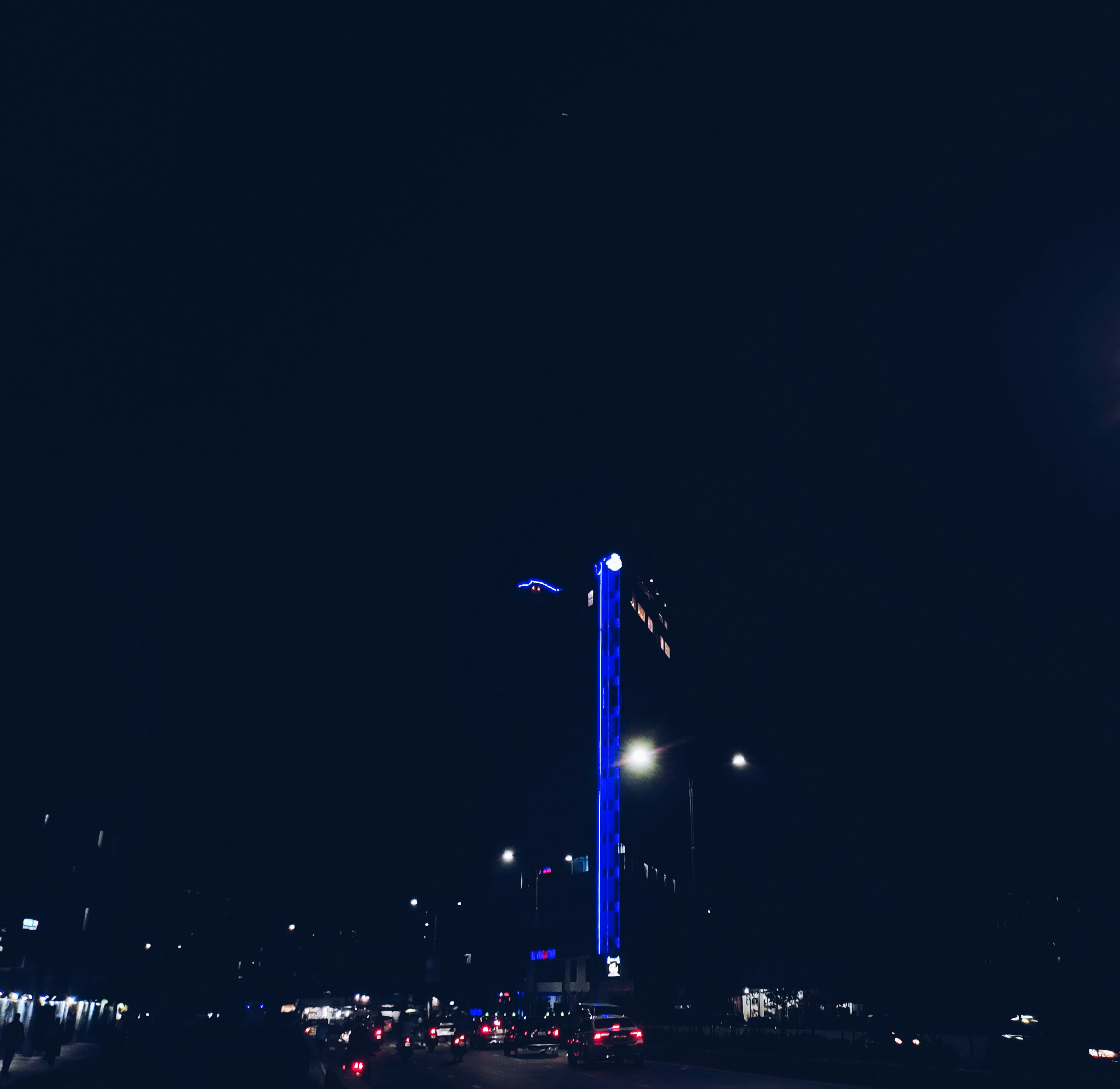 Blue Neon Spire Guarding a Quiet Night Street