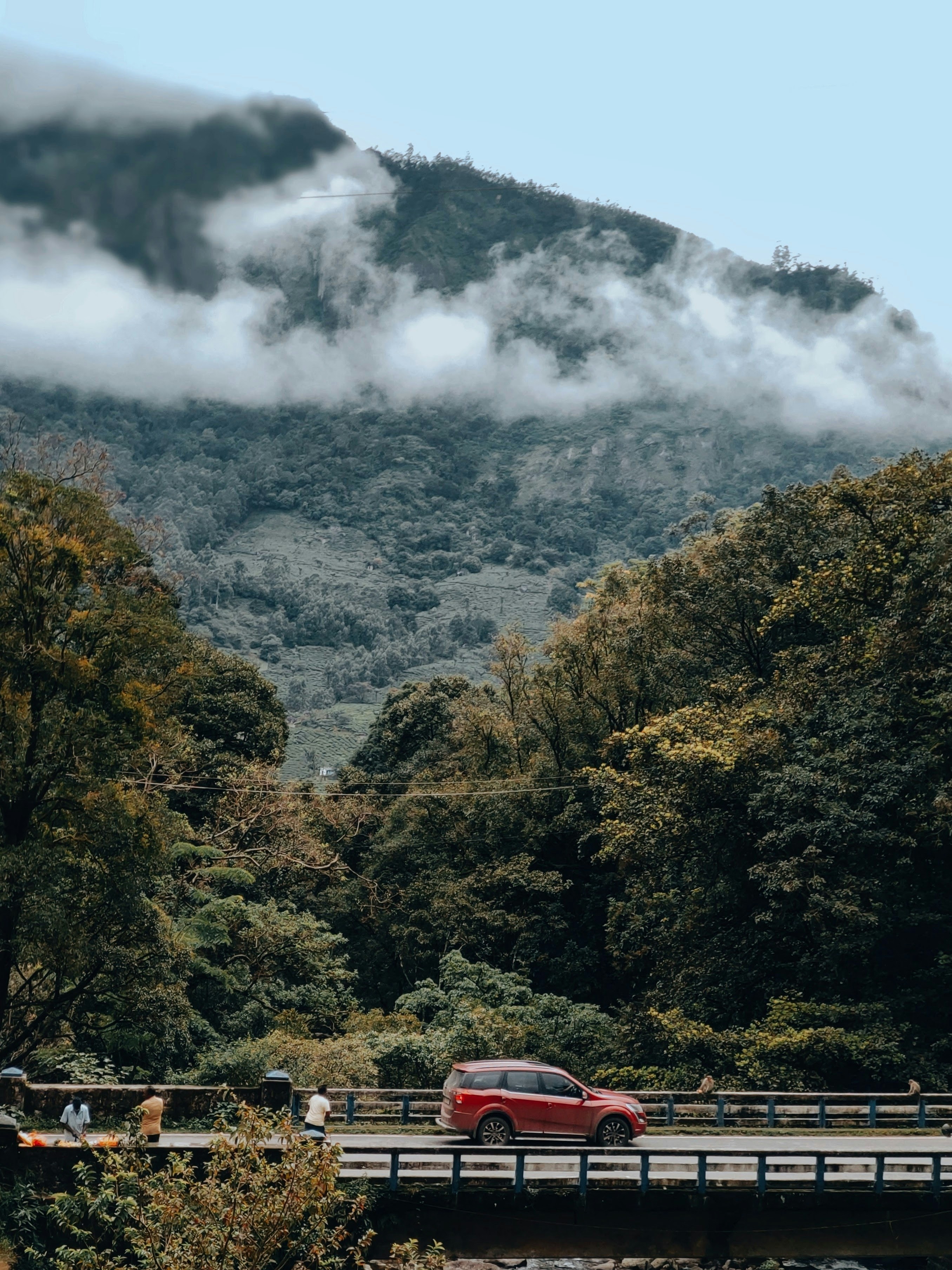 A red car driving on a bridge over a river photo – Free Munnar Image on ...