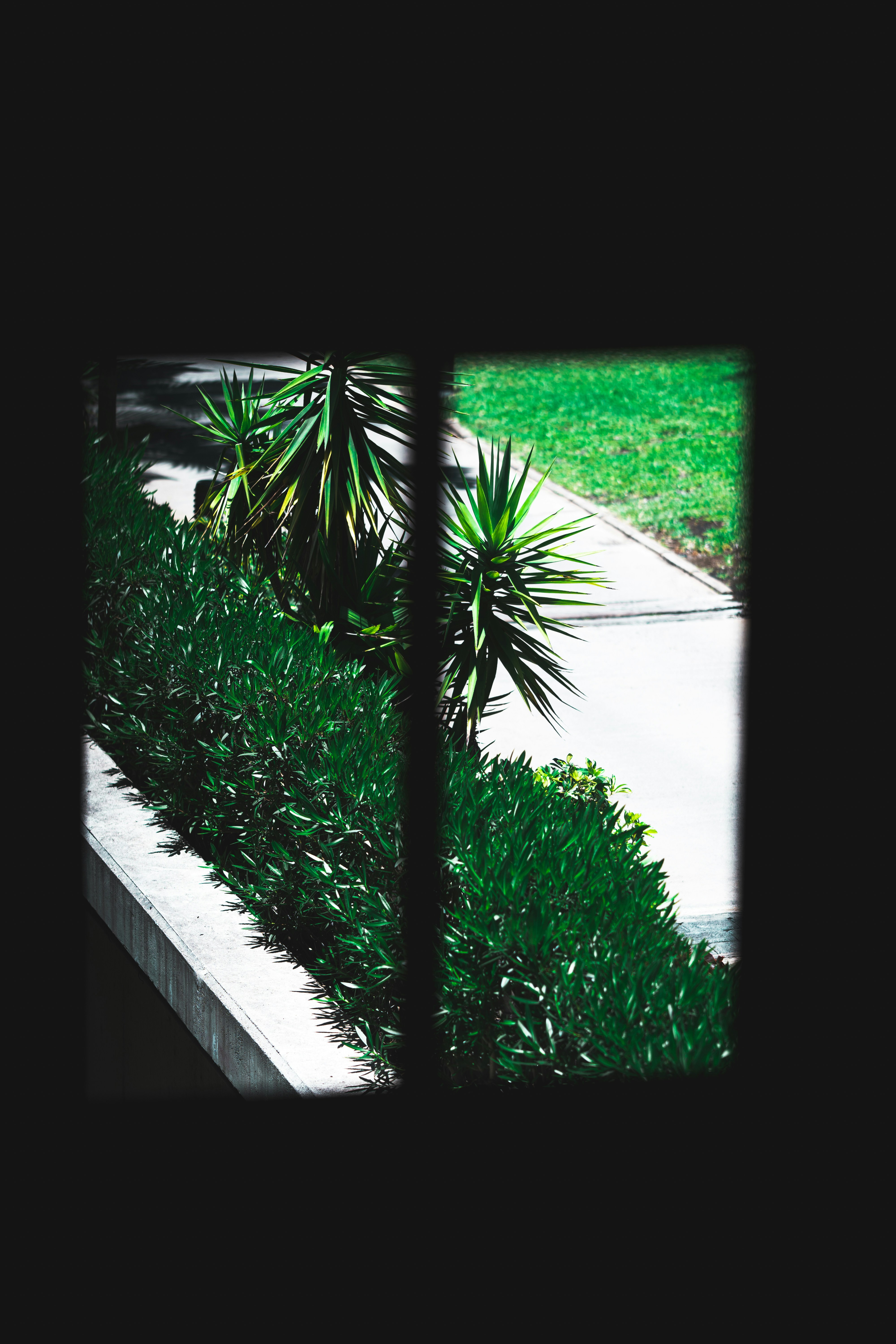 A view of a sidewalk through a window photo – Free Spain Image on Unsplash