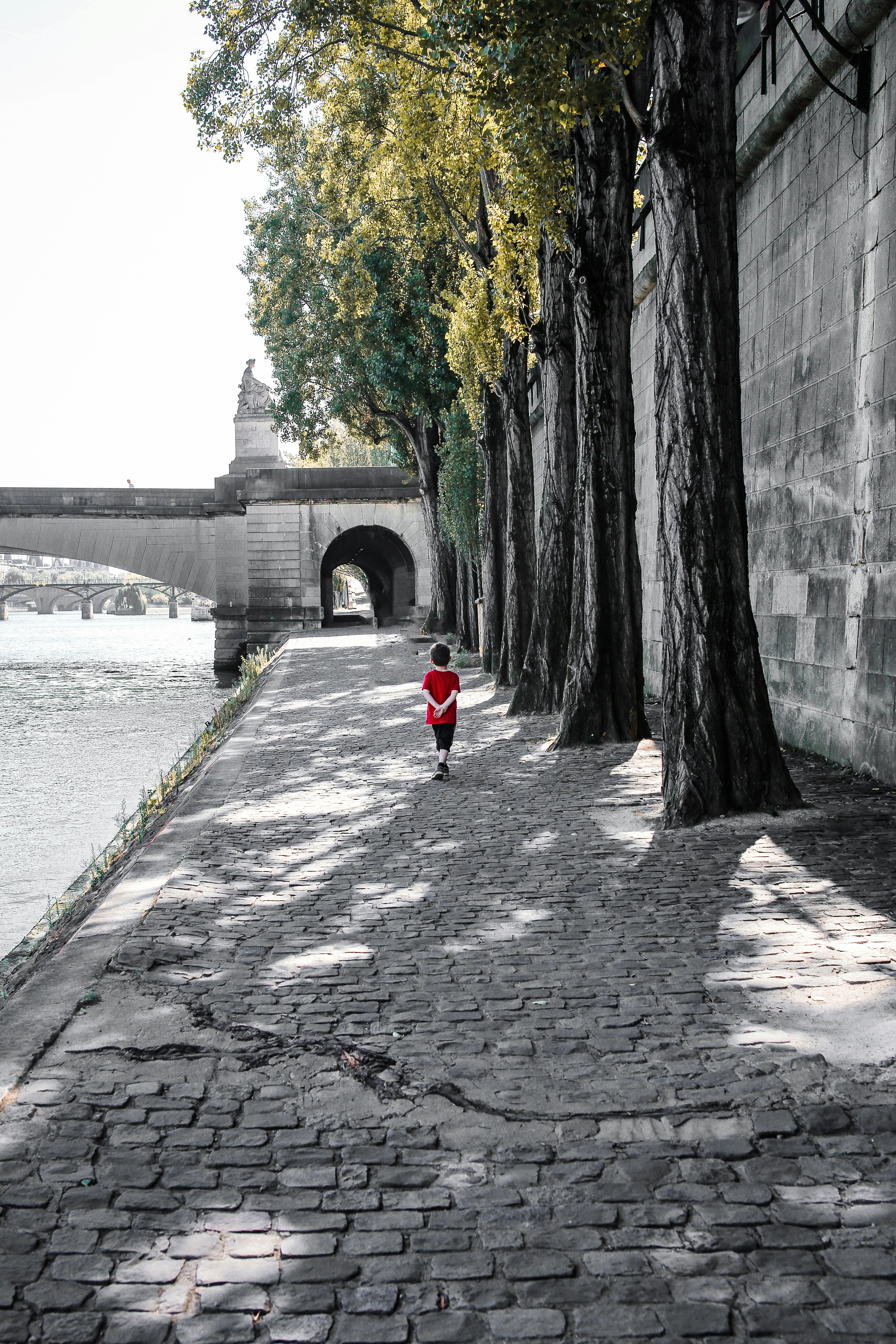 Red Shirt on the Cobblestone Riverwalk: A Quiet Journey Toward the Archlight