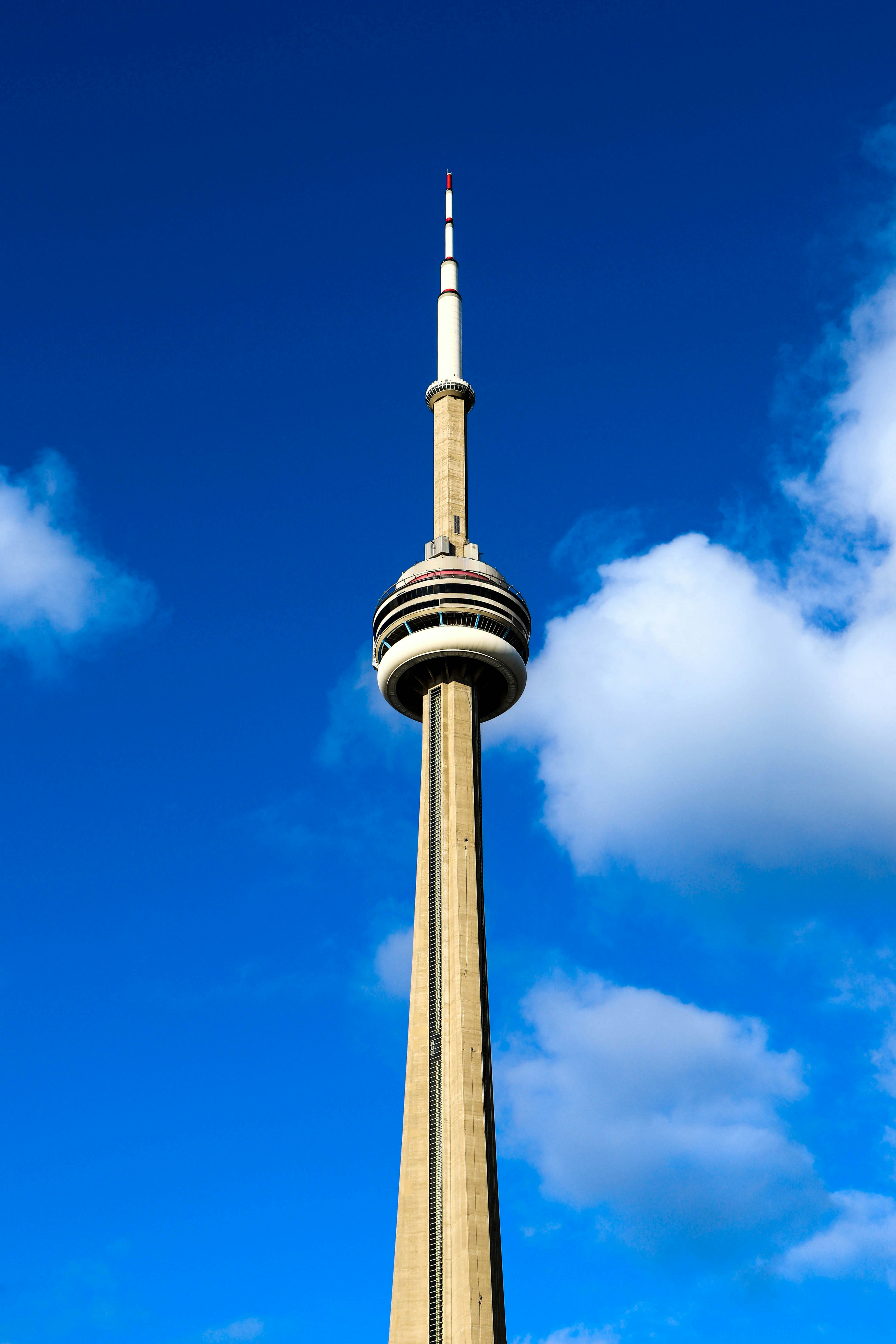 A very tall tower with a clock on it's side photo – Free Cn tower Image ...