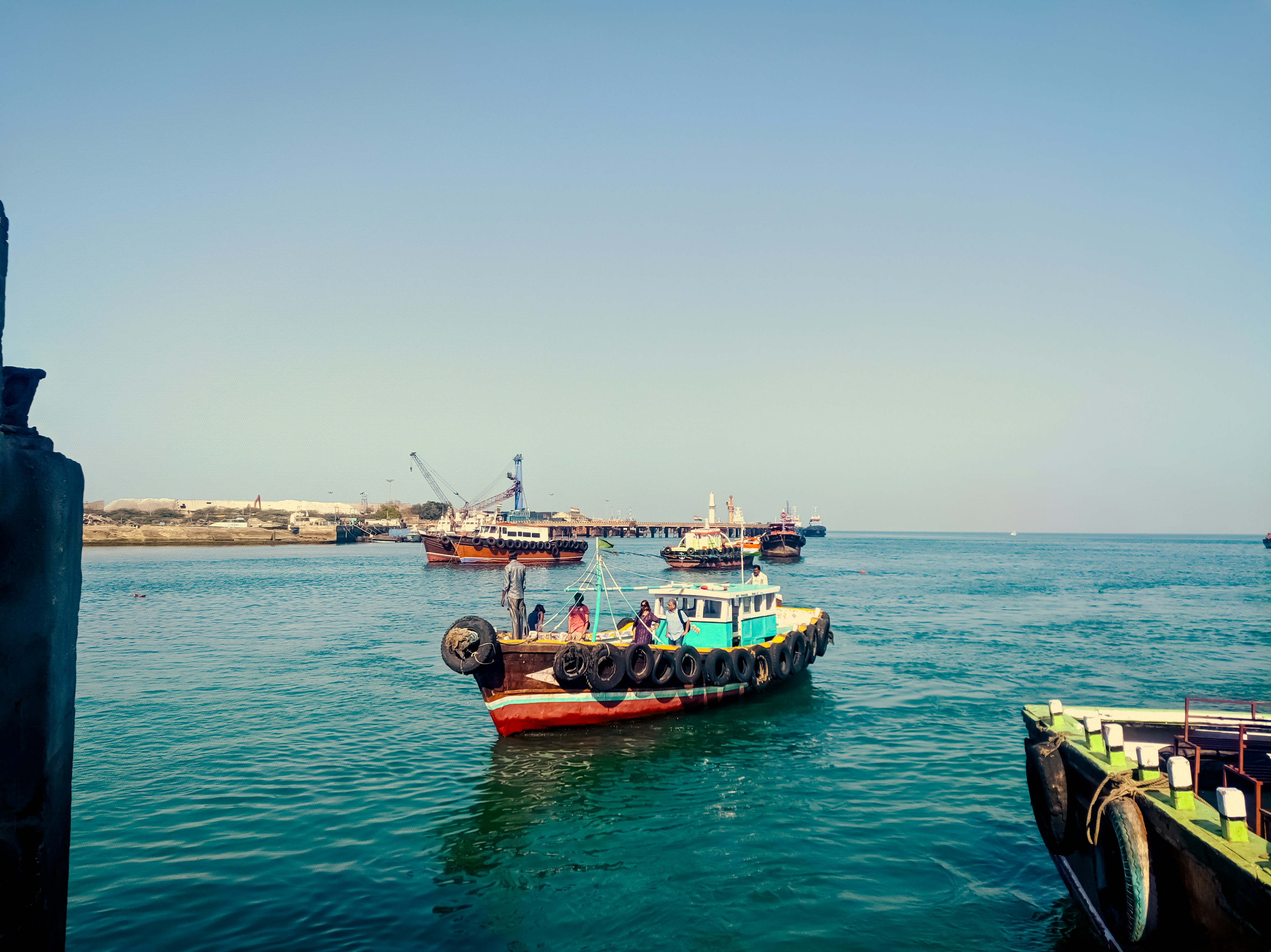 A group of boats floating on top of a body of water photo – Free India ...