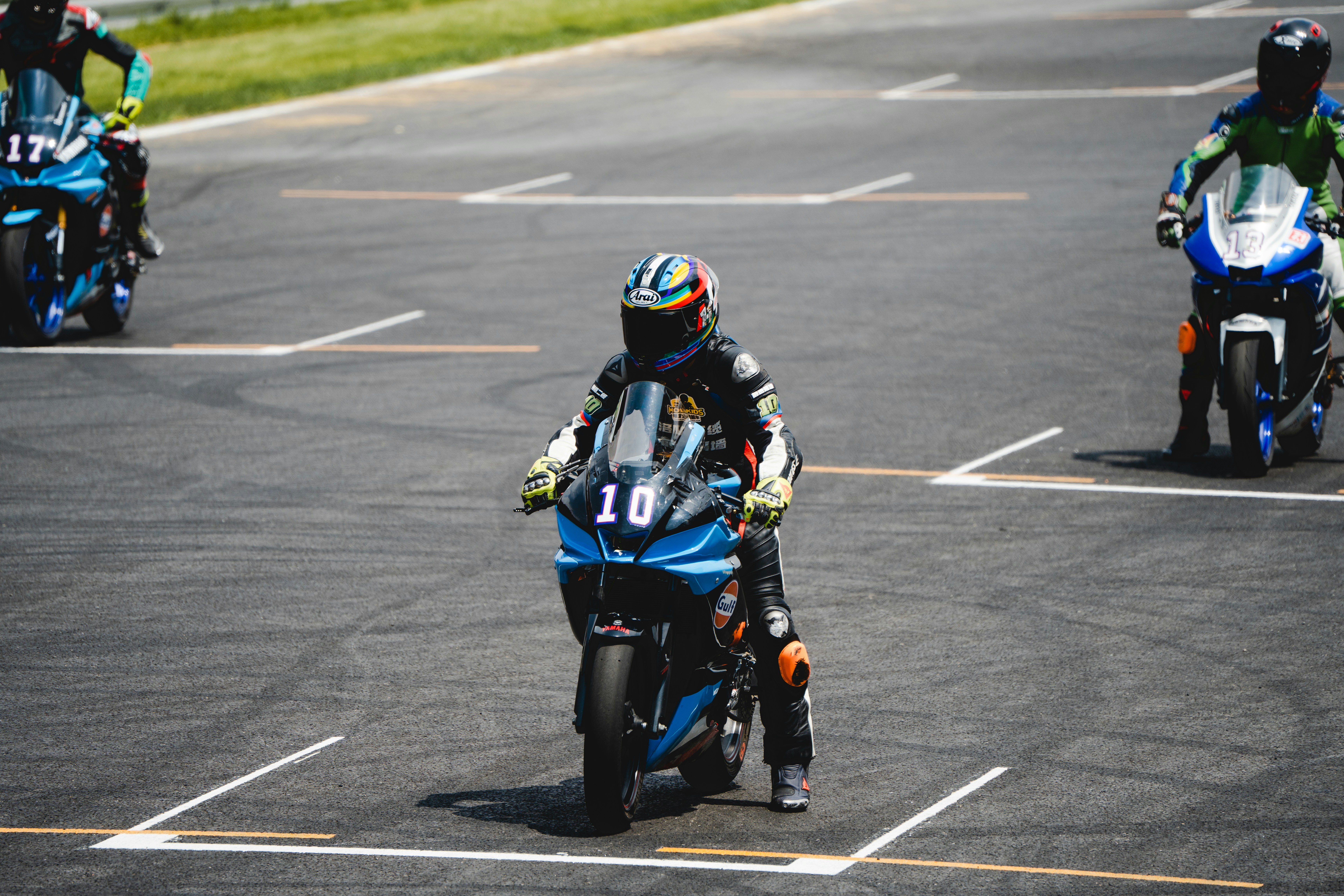 A group of people riding motorcycles on a race track photo – Free Bmw ...
