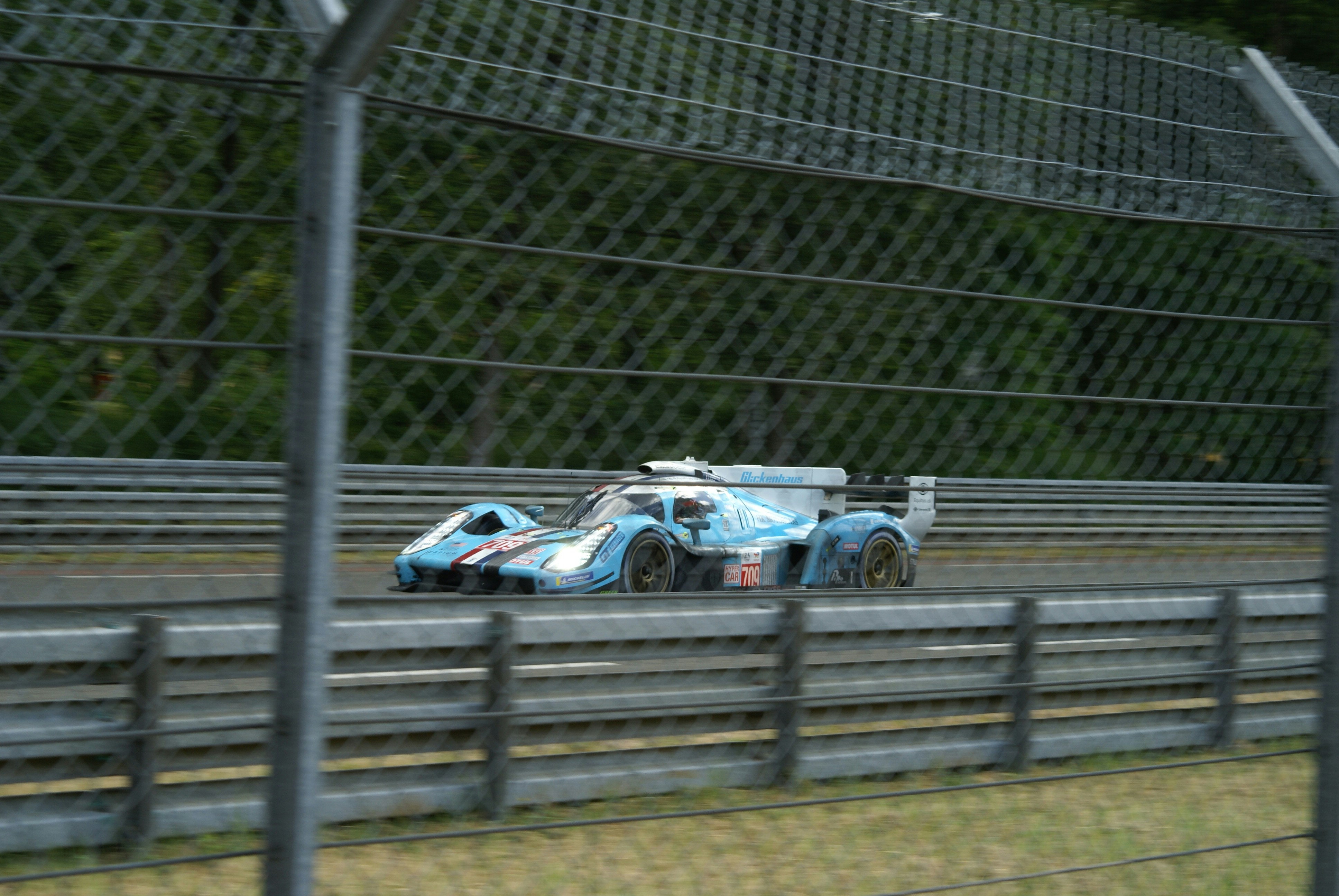 A blue race car driving down a race track photo – Free Le mans 24 hours ...