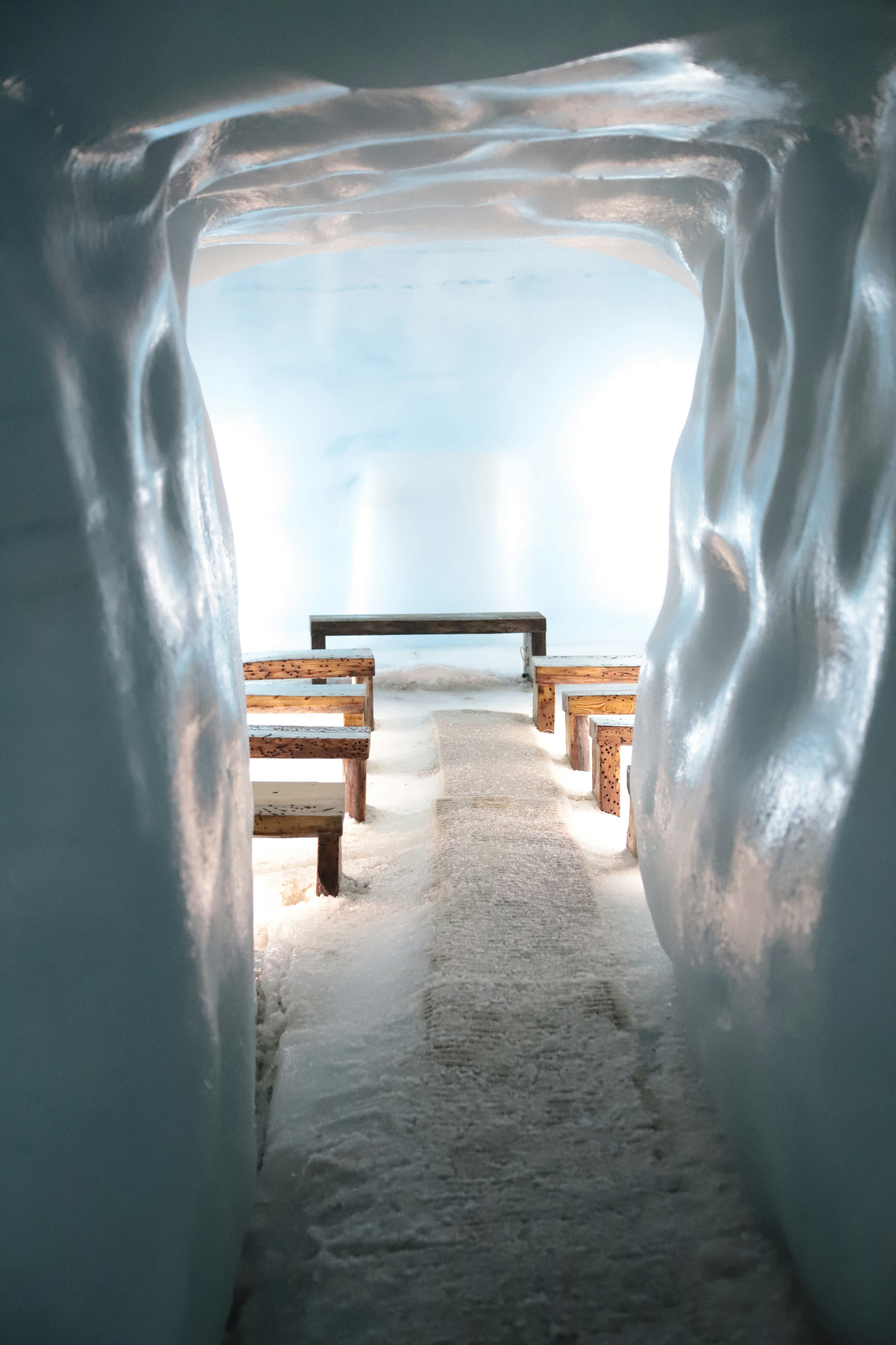 Glacial Aisle: Benches Align Toward a Bright Ice Exit