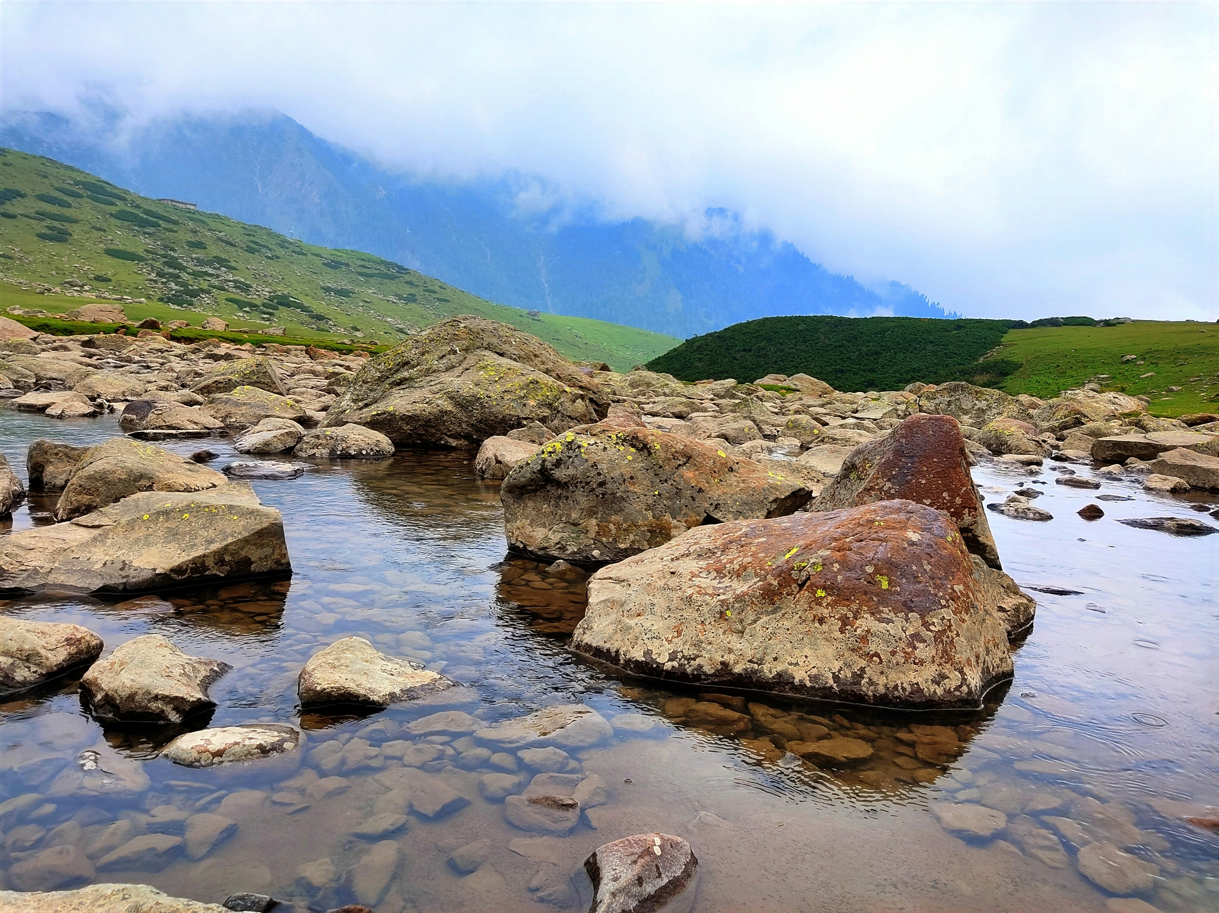 Granite Mosaic by a Cloud-Soft Alpine Stream