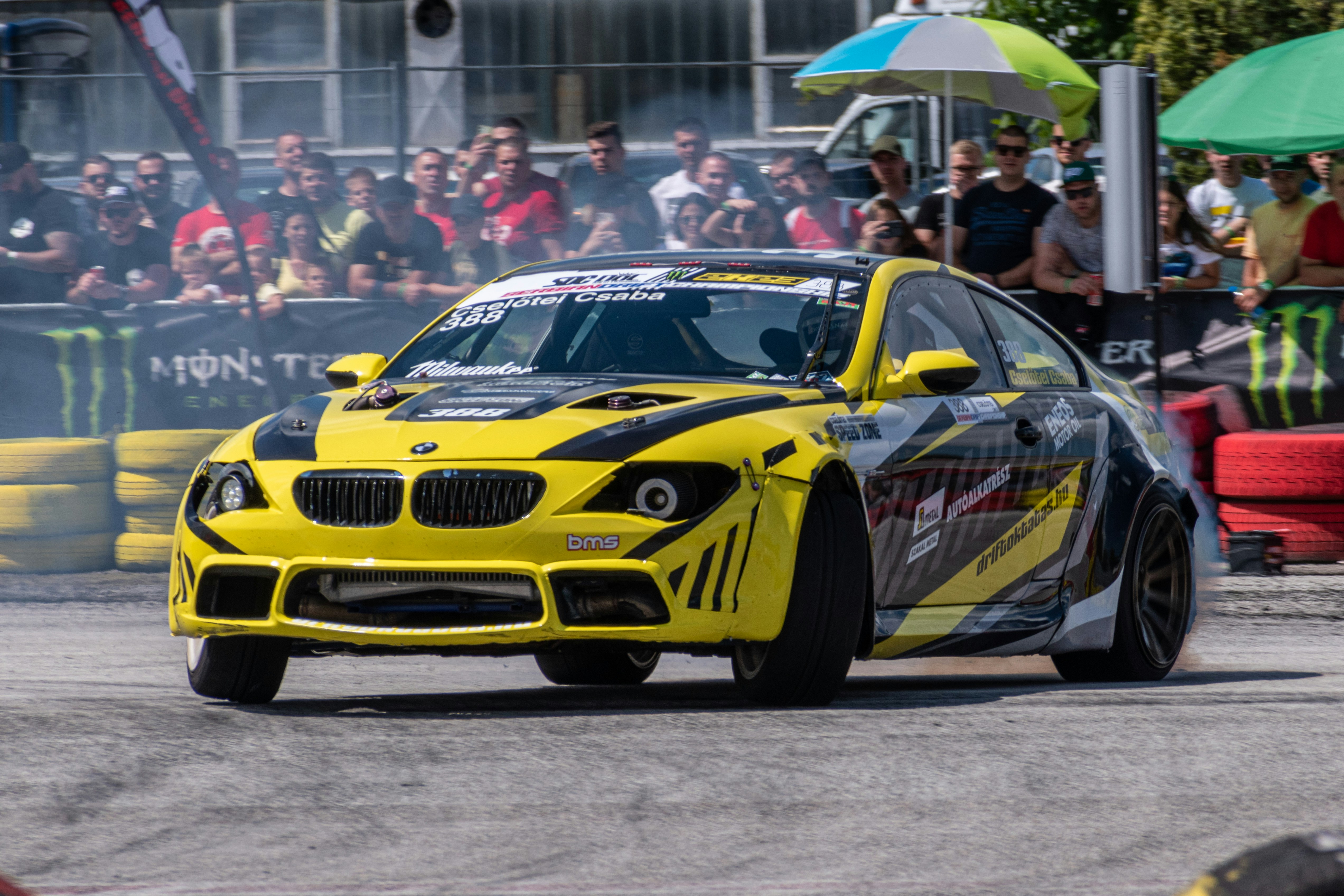 A yellow car driving down a race track photo – Free Serbia Image on ...