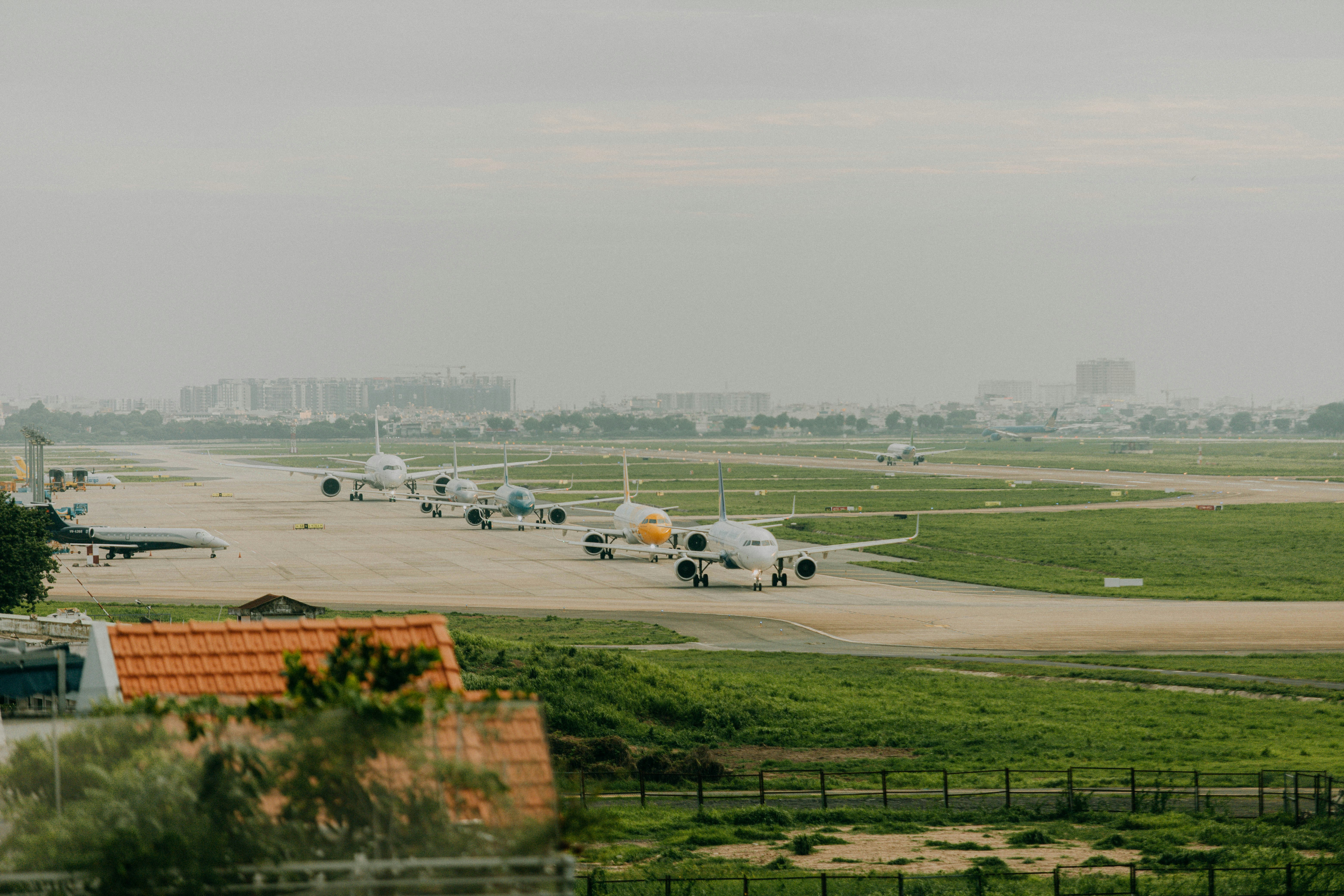 Dawn Mist Over a Row of Taxiing Jets on the Runway