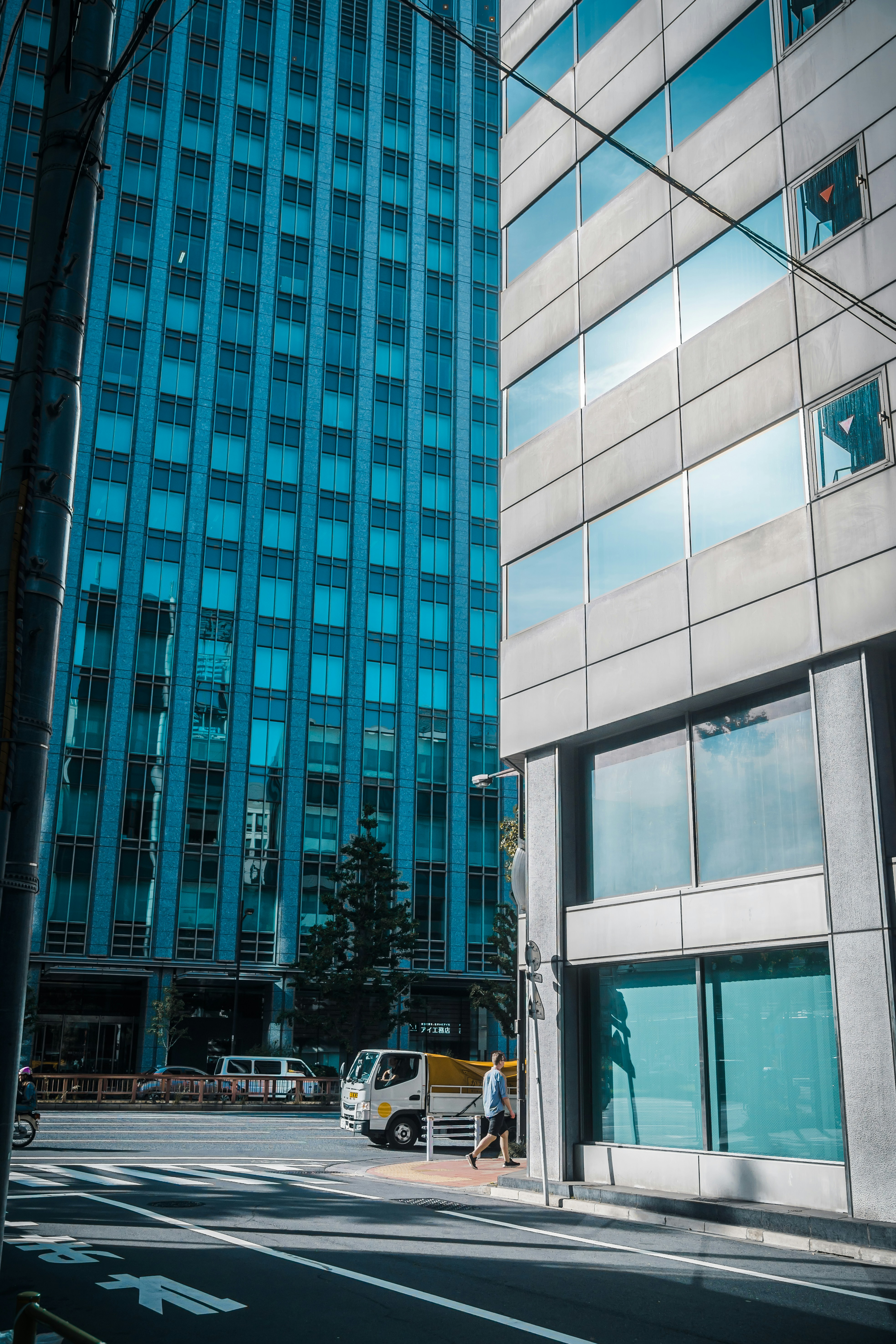 Pedestrian Crossing Between Azure Glass Facades