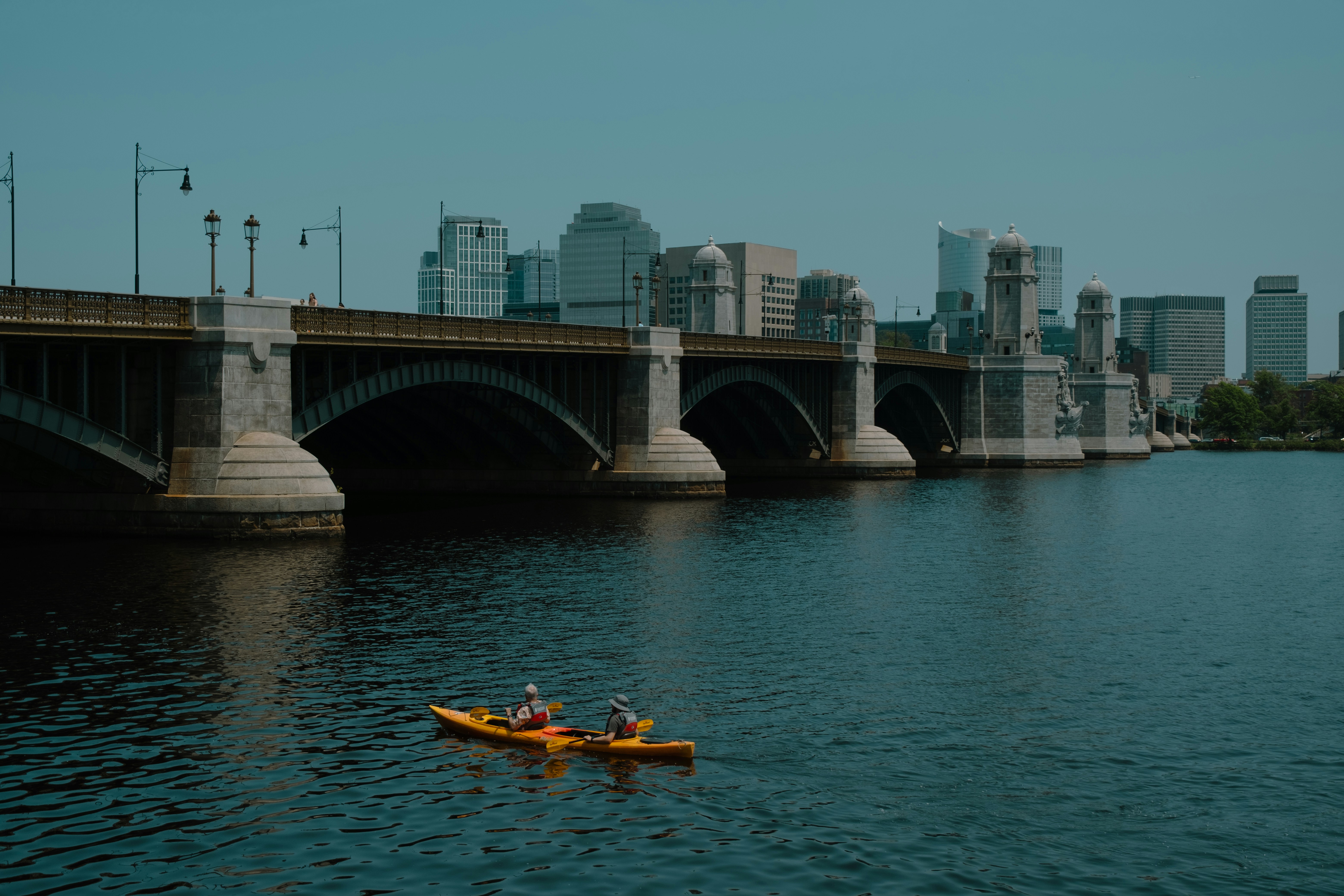 Golden Kayak Under the Riverside Skyline