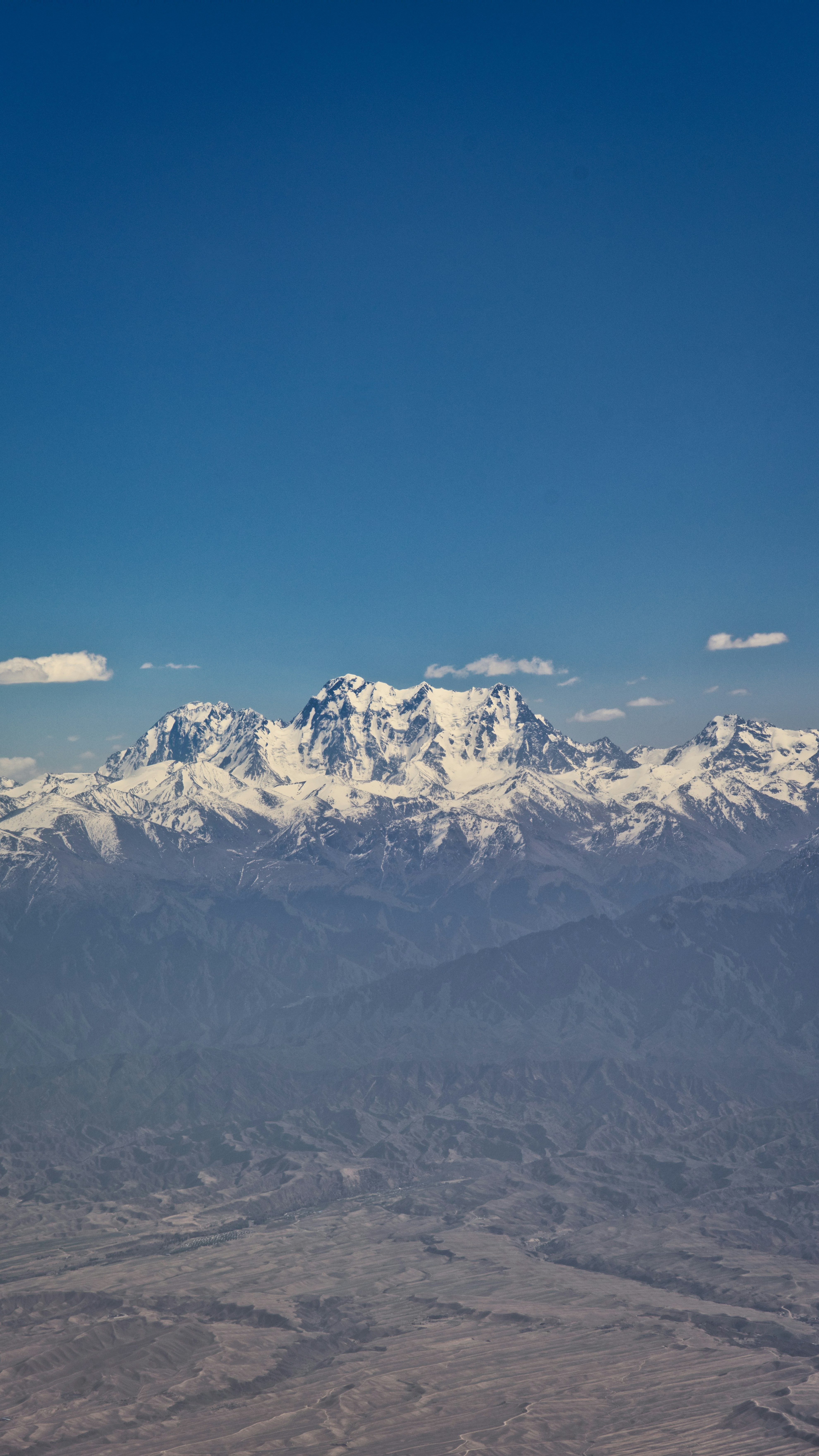 A view of a snowy mountain range from an airplane photo – Free Mount ...