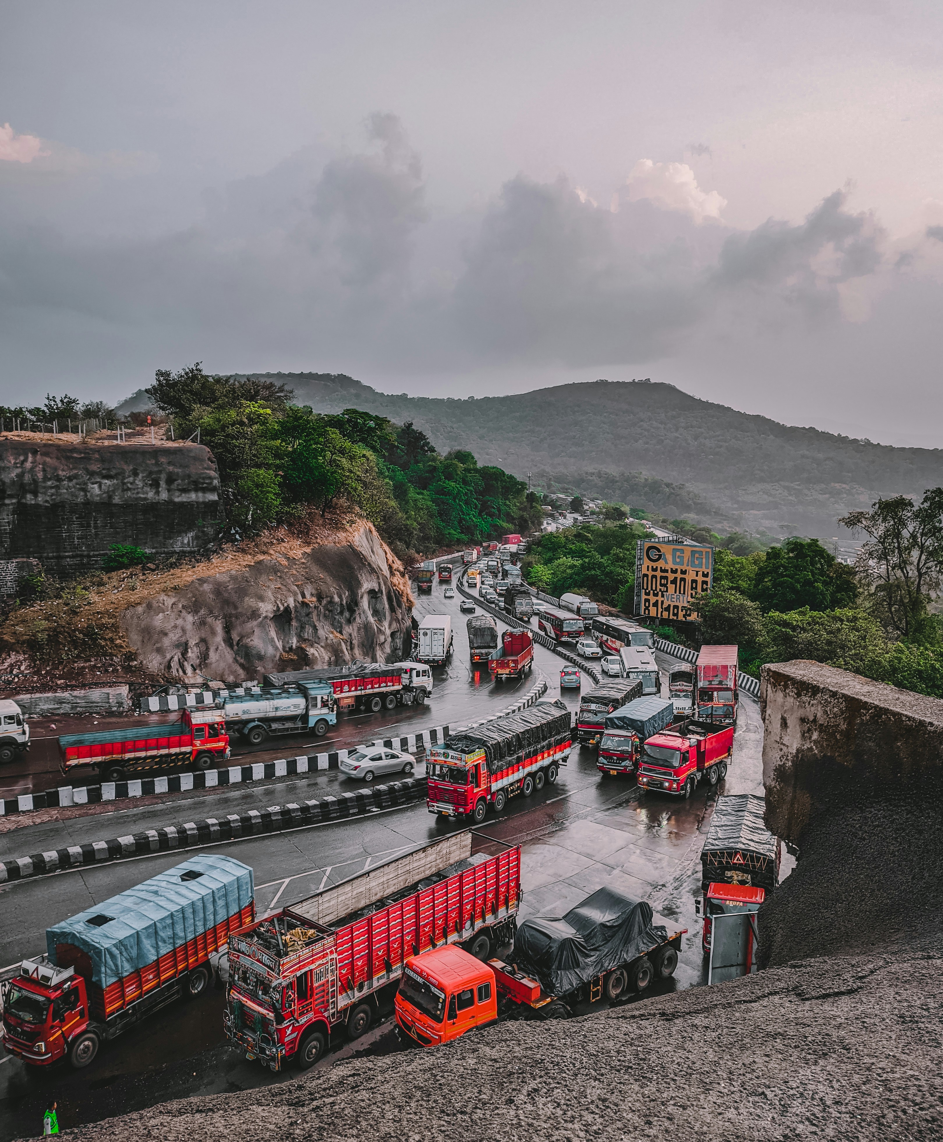 Red Confluence: Truck Alley on a Winding Mountain Pass