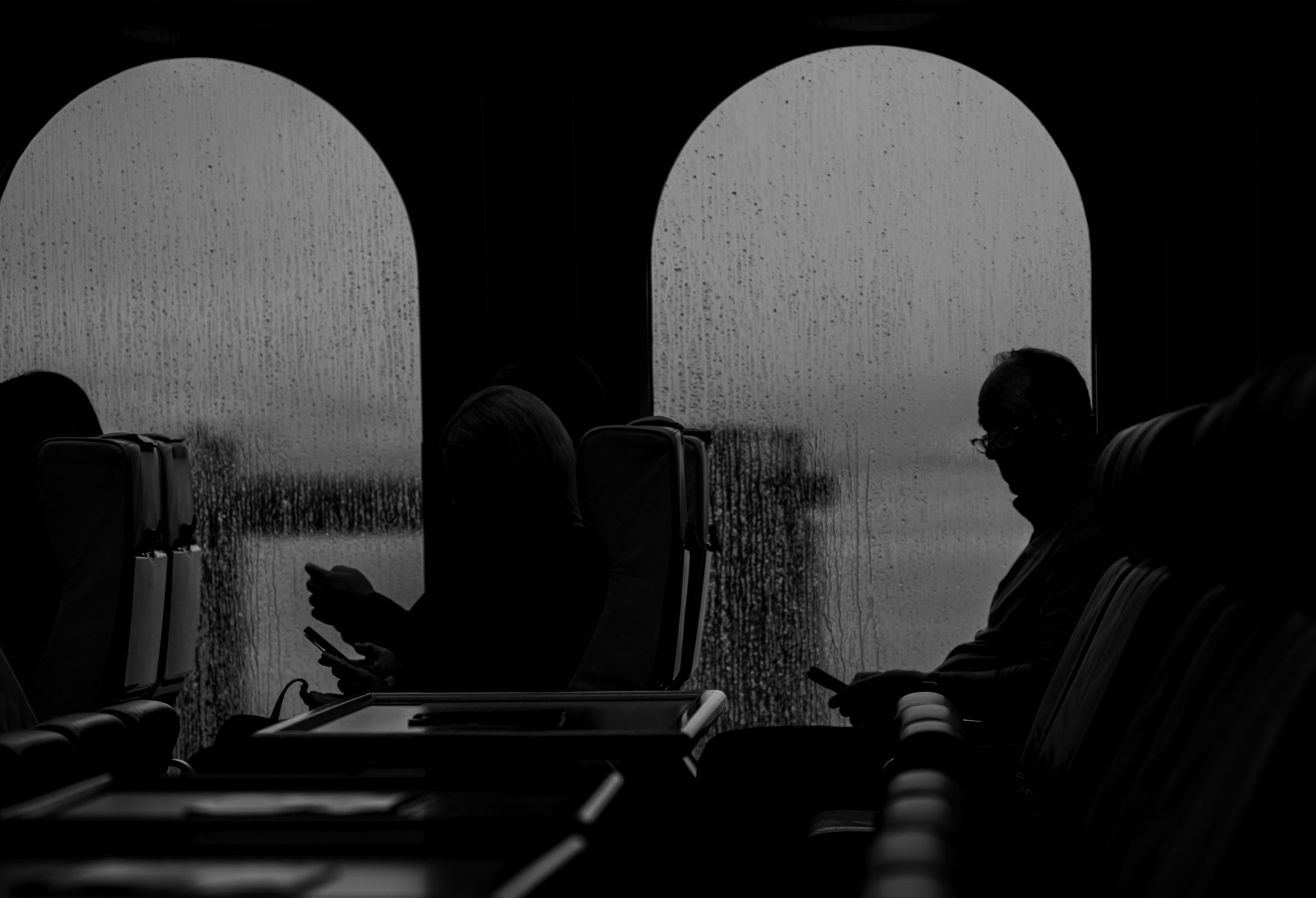 Rain-Streaked Windows and Silent Silhouettes: An Aisle-Seat Moment