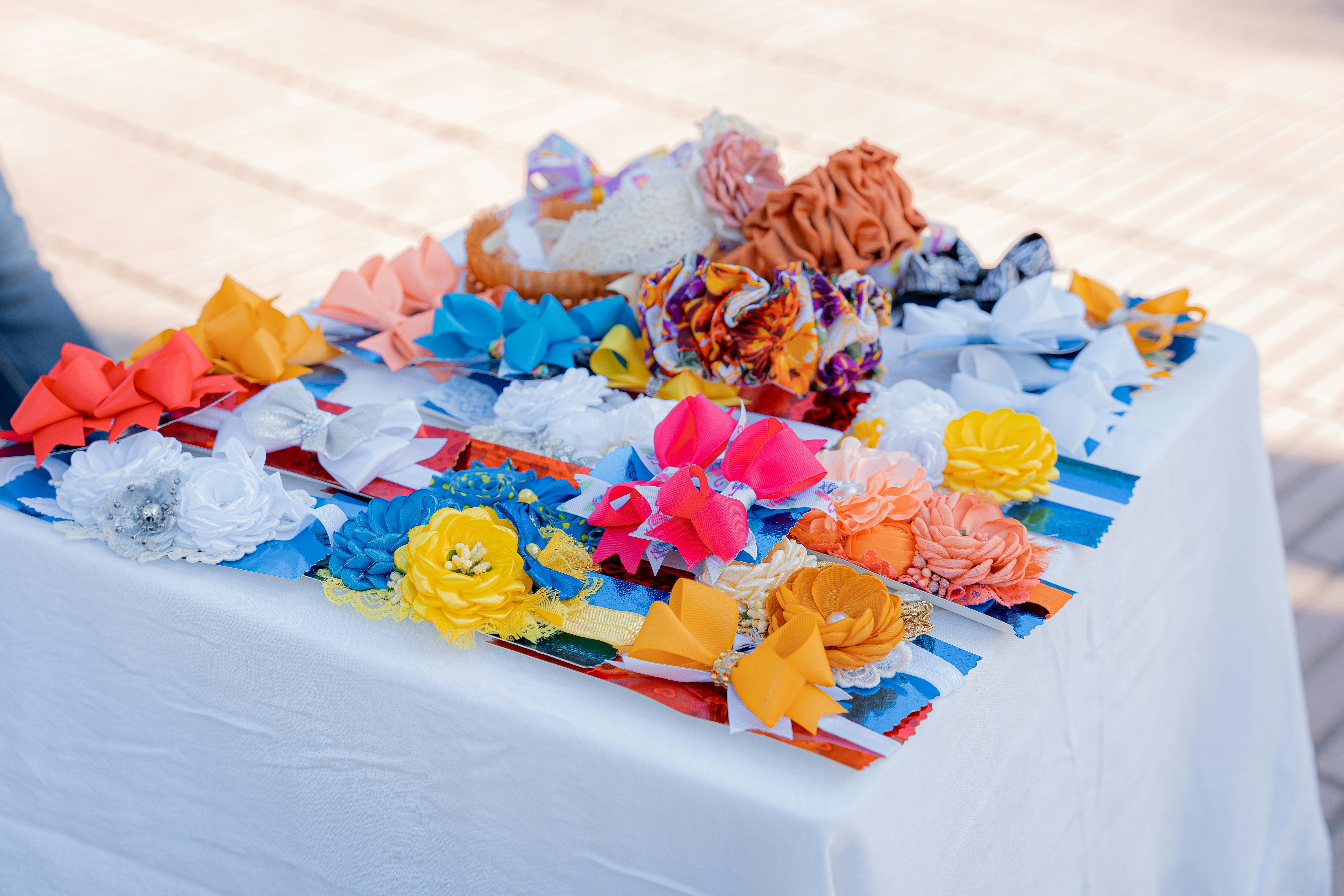 Colorful assortment of bows arranged on a white table under natural light.