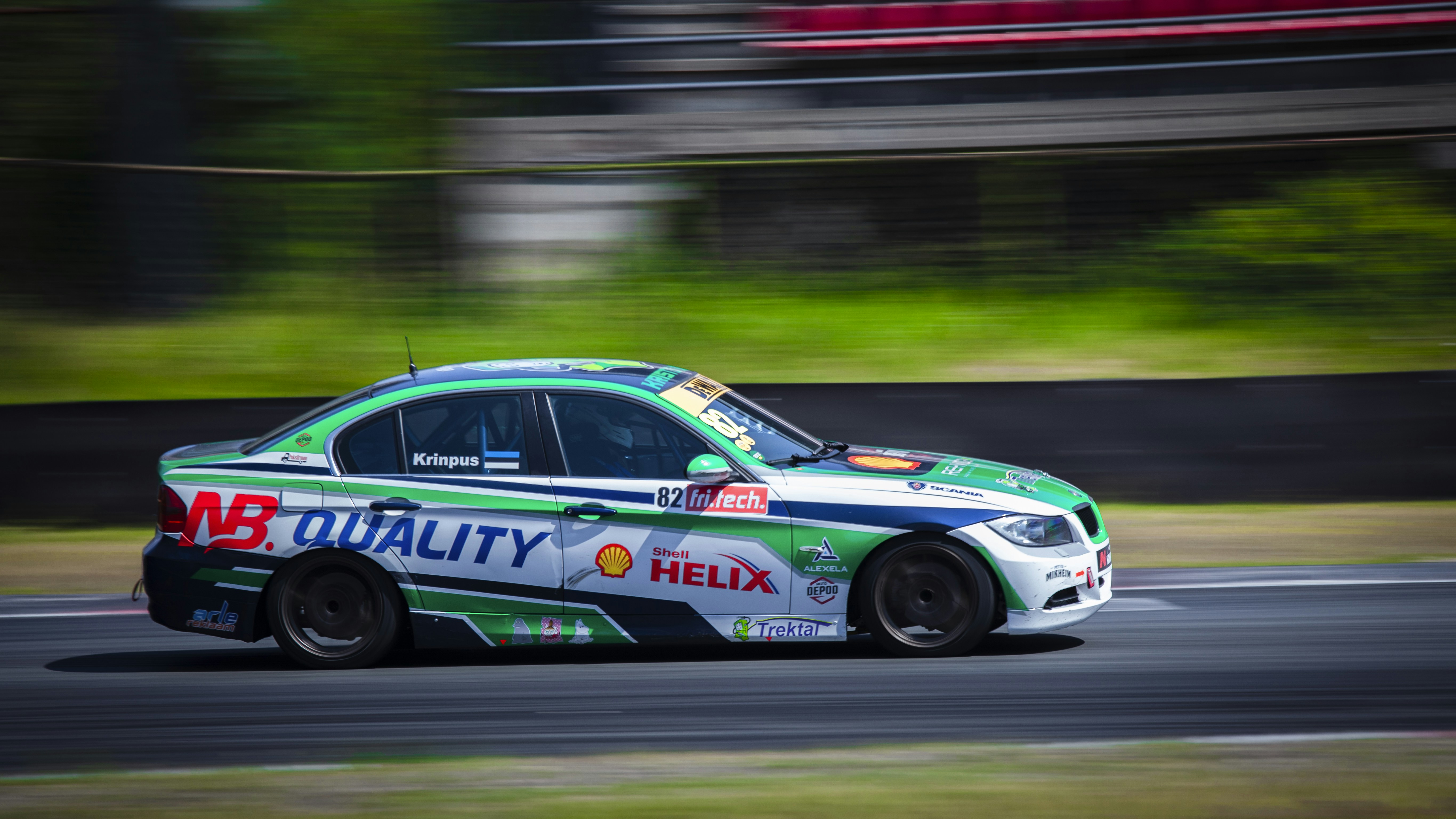 Neon-Teal Race Car Slicing the Circuit at Speed
