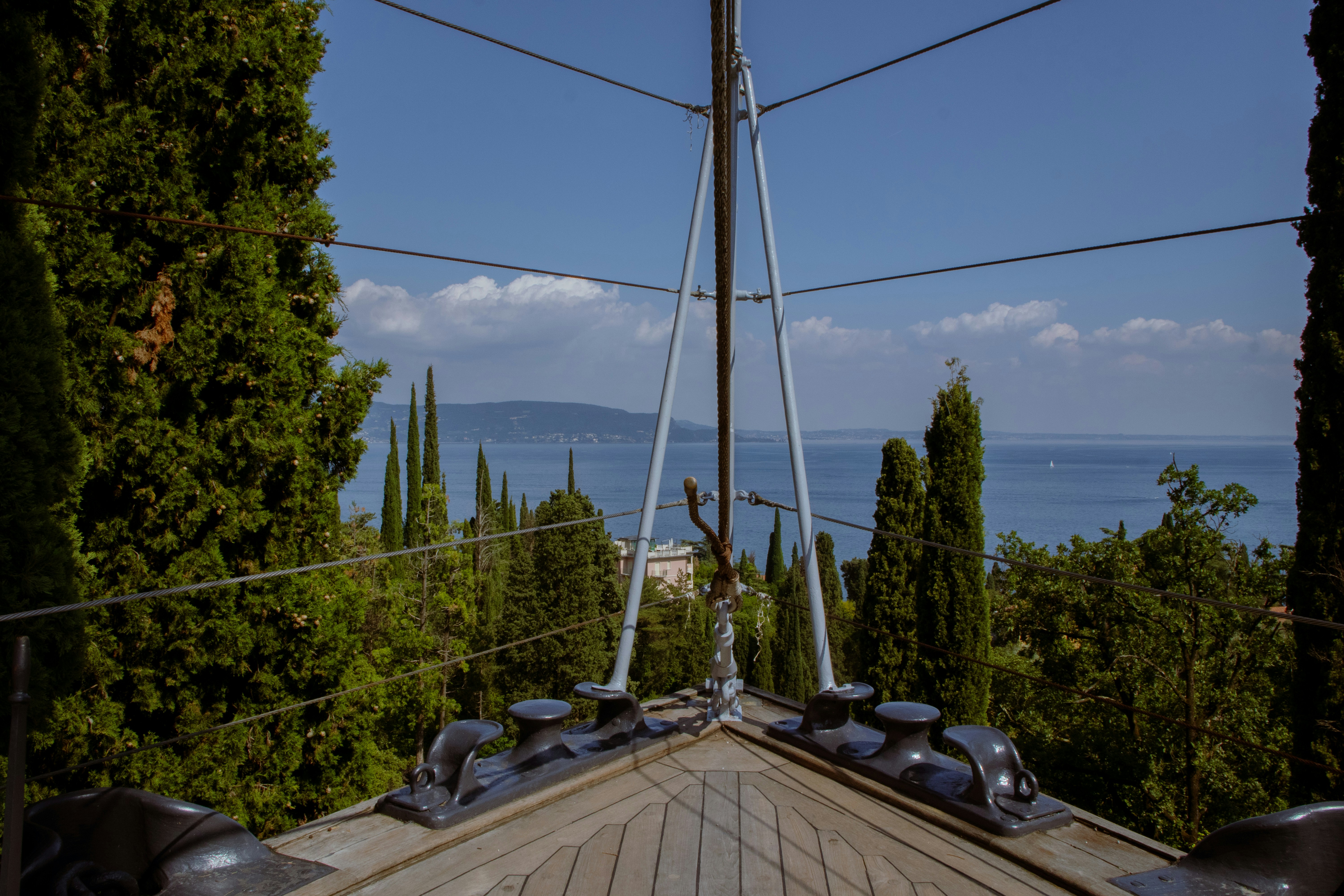 Rooftop Conductor: Antenna Wires Framing a Terrace Over the Sea