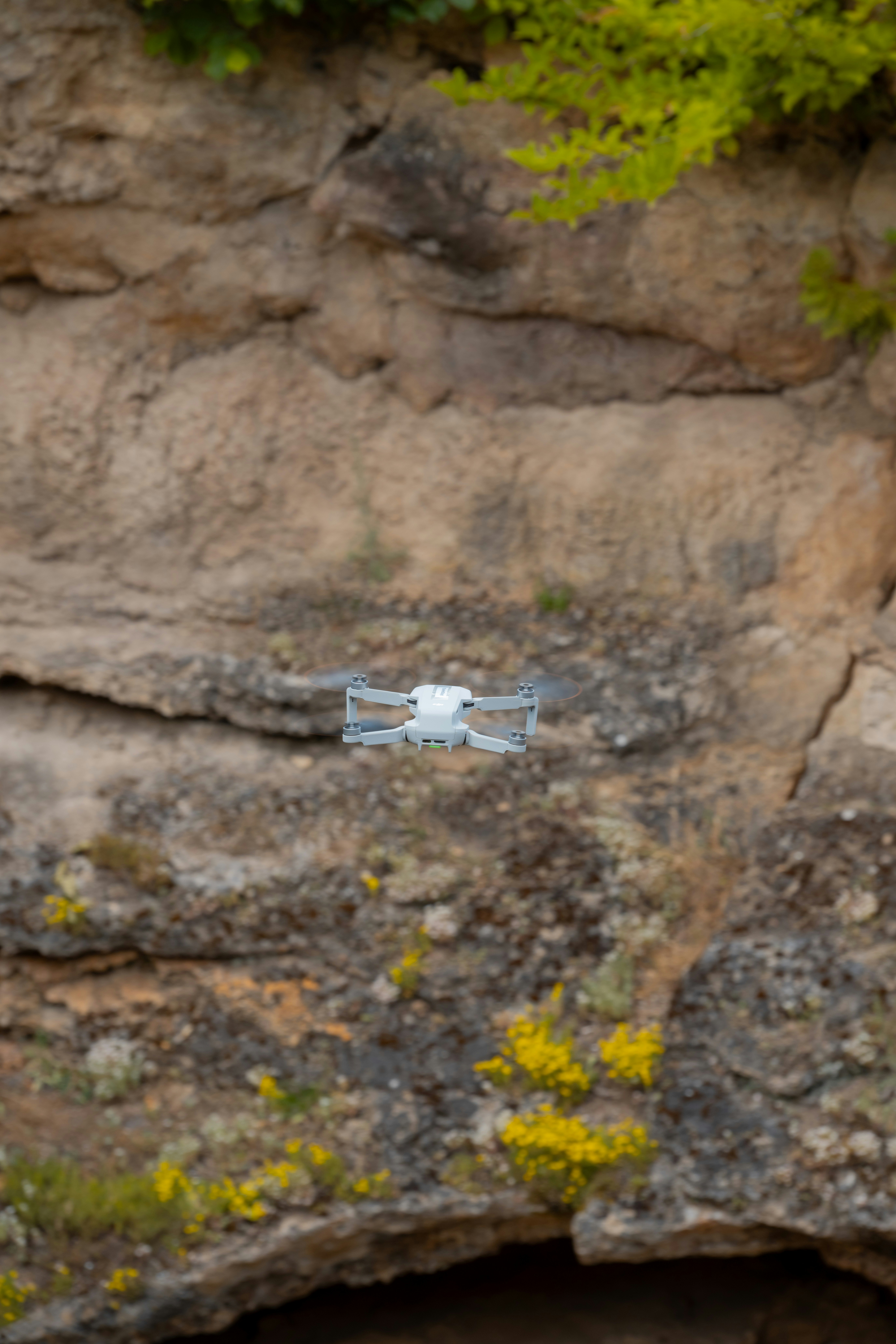 Tiny Drone Over a Weathered Cliff in Spring Light