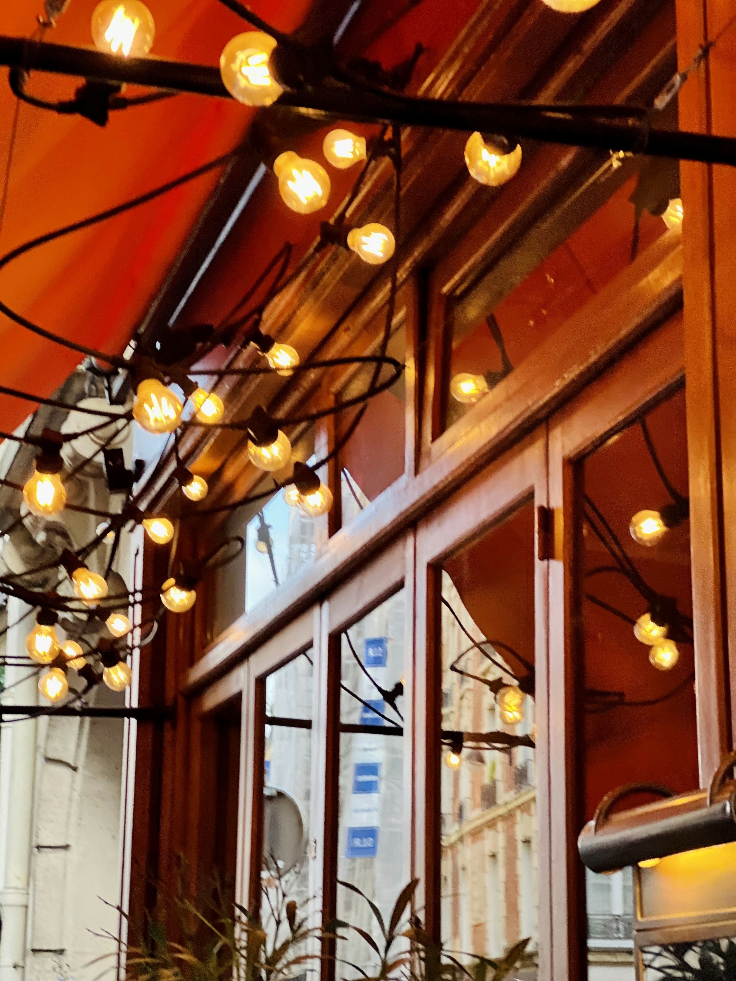 I loved the warm glow of the electric lights against the red awnings of this quaint restaurant in the 16th arrondissement of Paris, France.