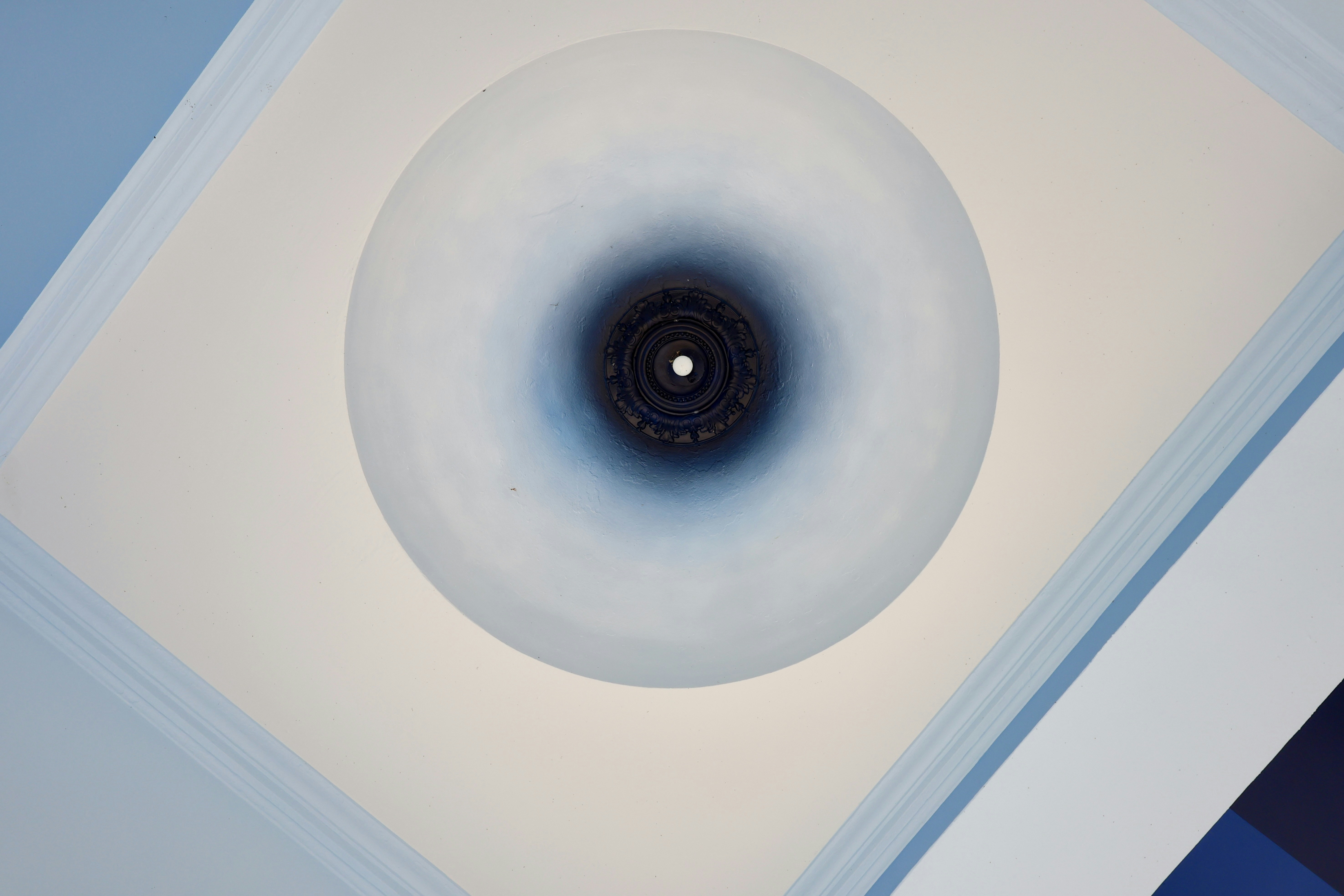 a white ceiling with a circular light fixture