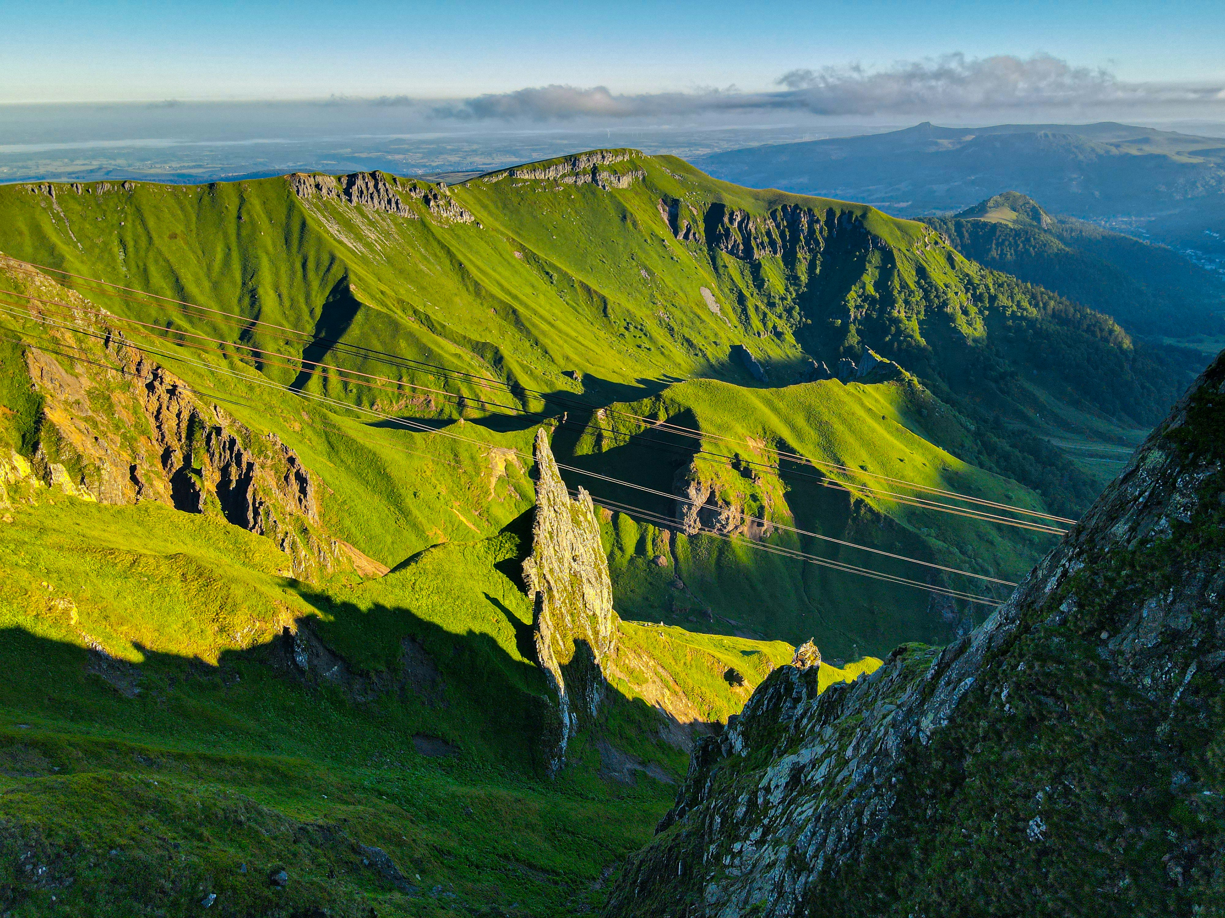 Serpentine Ridge: Aerial Tramlines Cut Through the Green Vastness