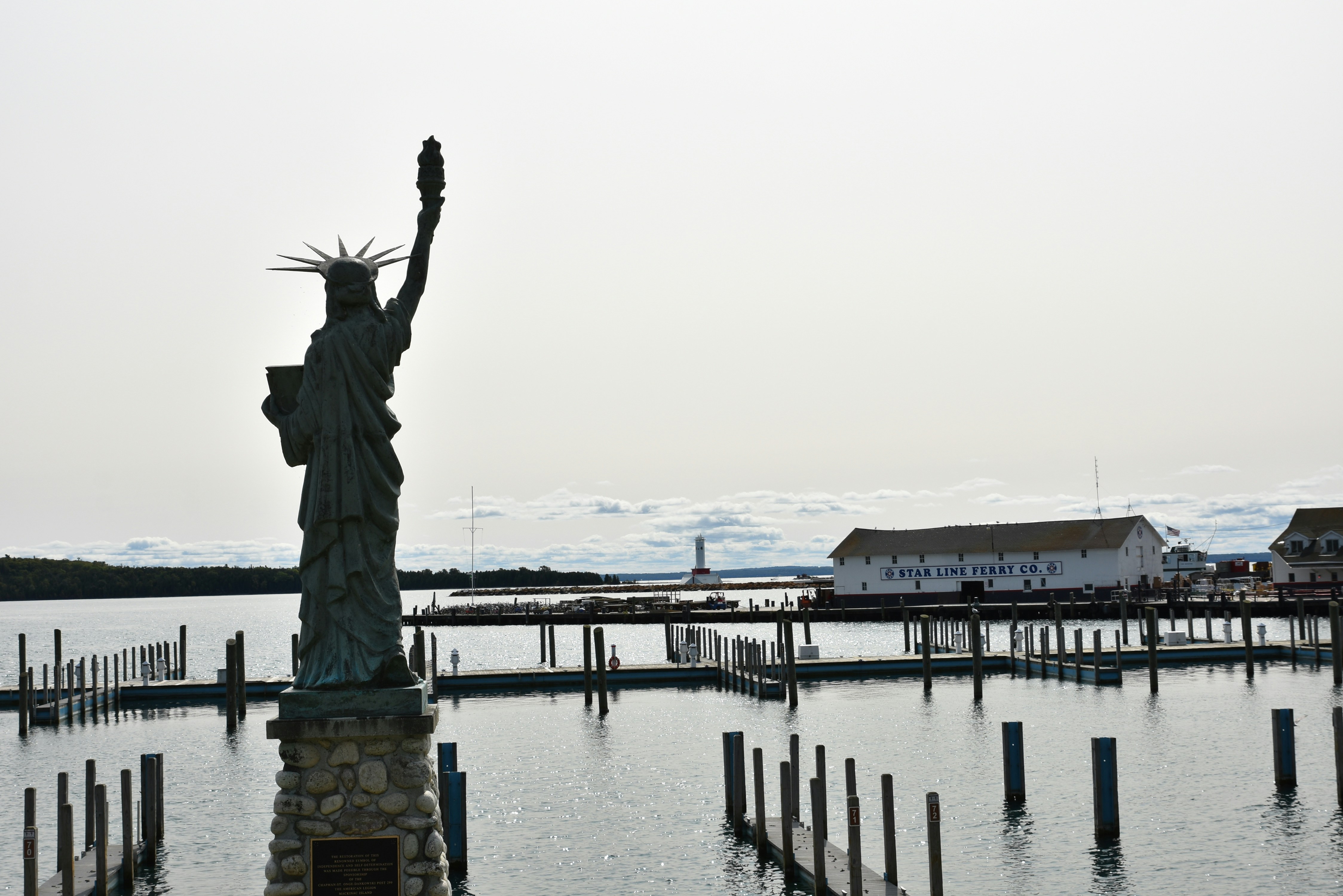 Harbor Sentinel: The Statue Over the Quiet Docks