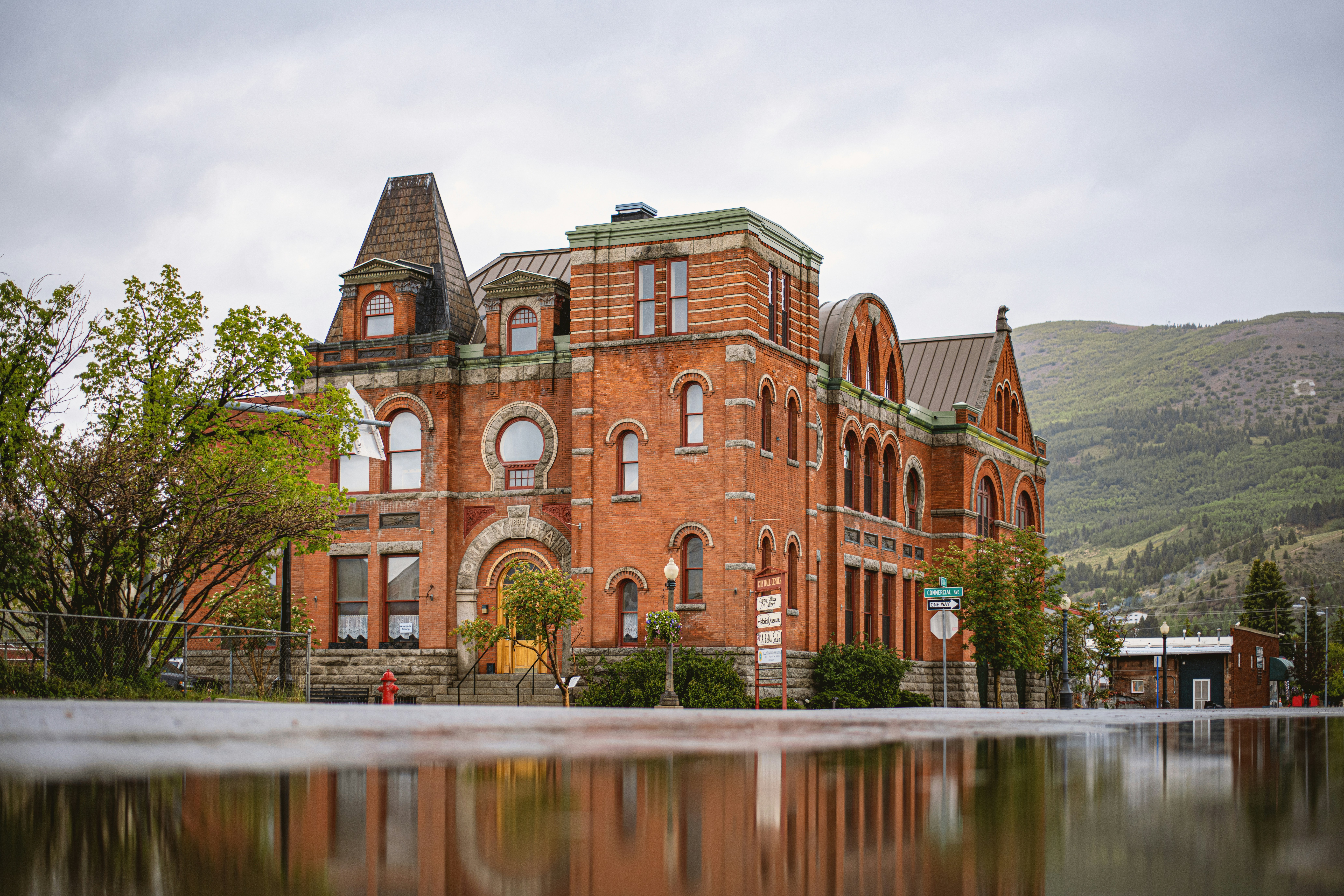 a large red brick building sitting next to a lake