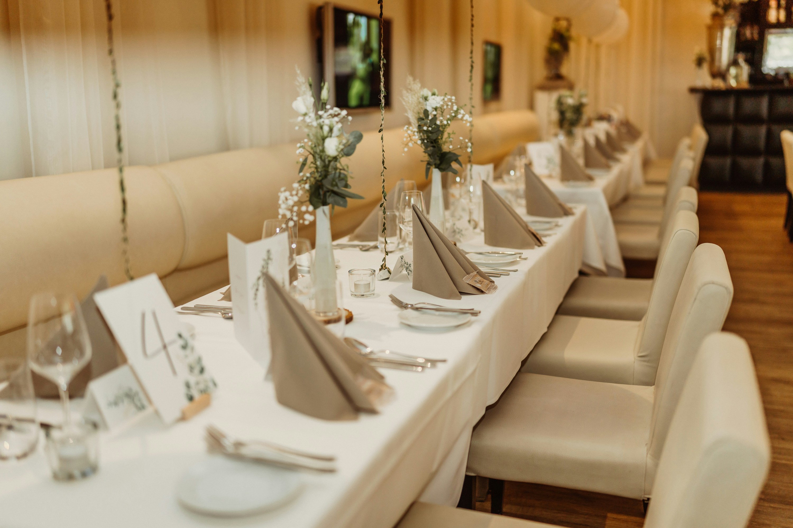 A long table with white table cloths and place settings photo – Free ...