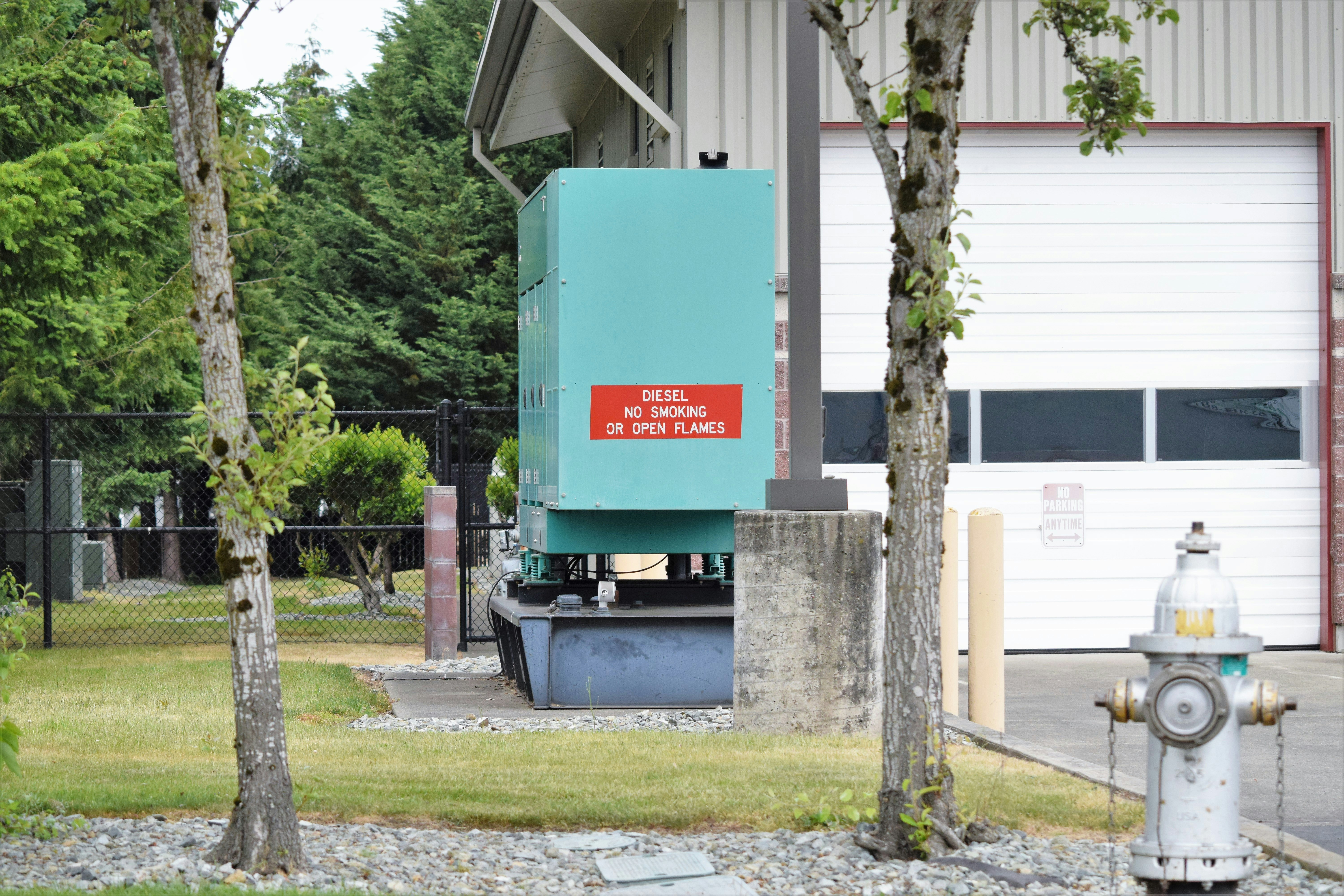 A fire hydrant in front of a building with a sign on it photo – Free Wa ...