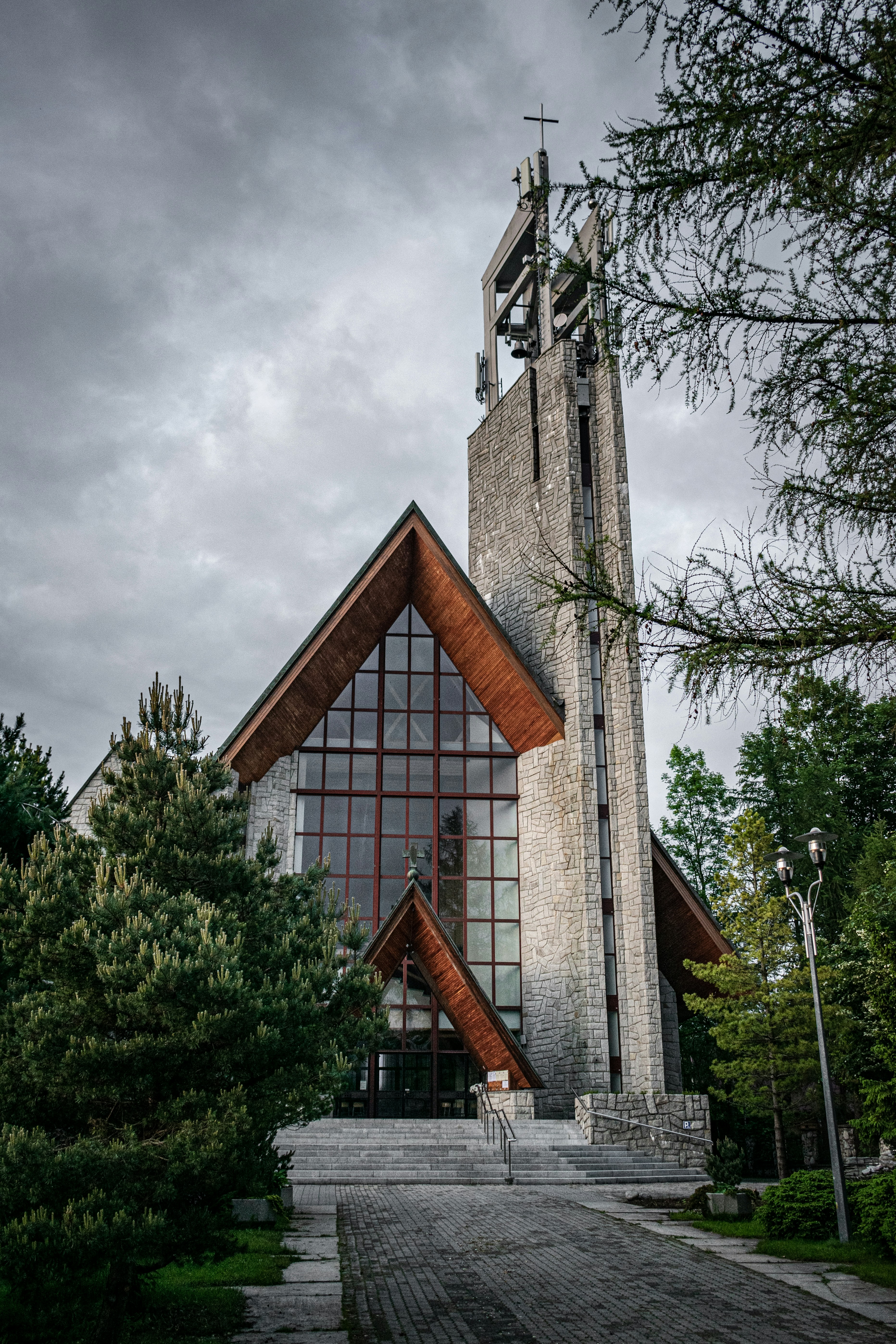 Triangular Glass and Tower: A Quiet Church Under Cloudy Skies