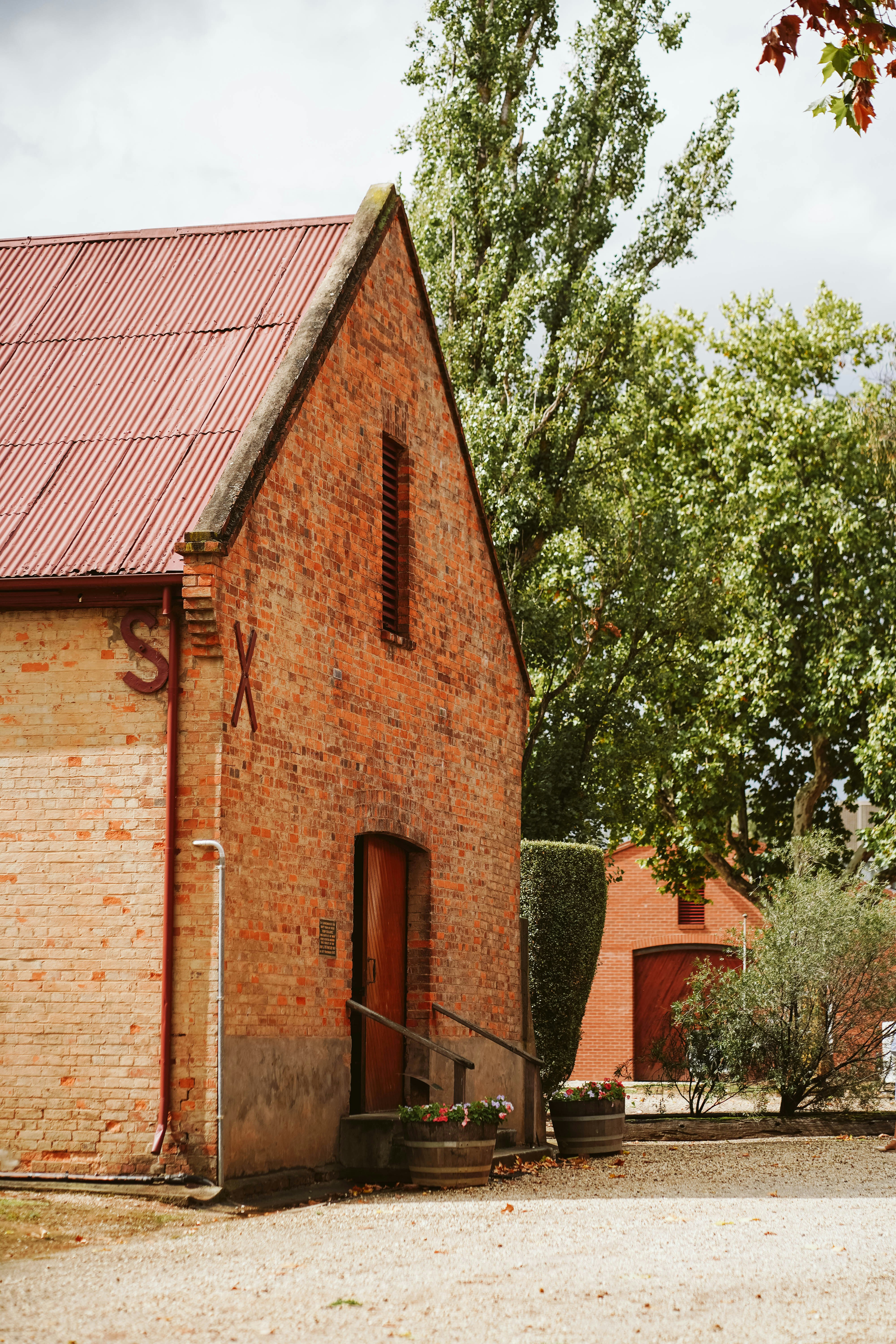 Crimson Roof and Weathered Brick in a Quiet Courtyard