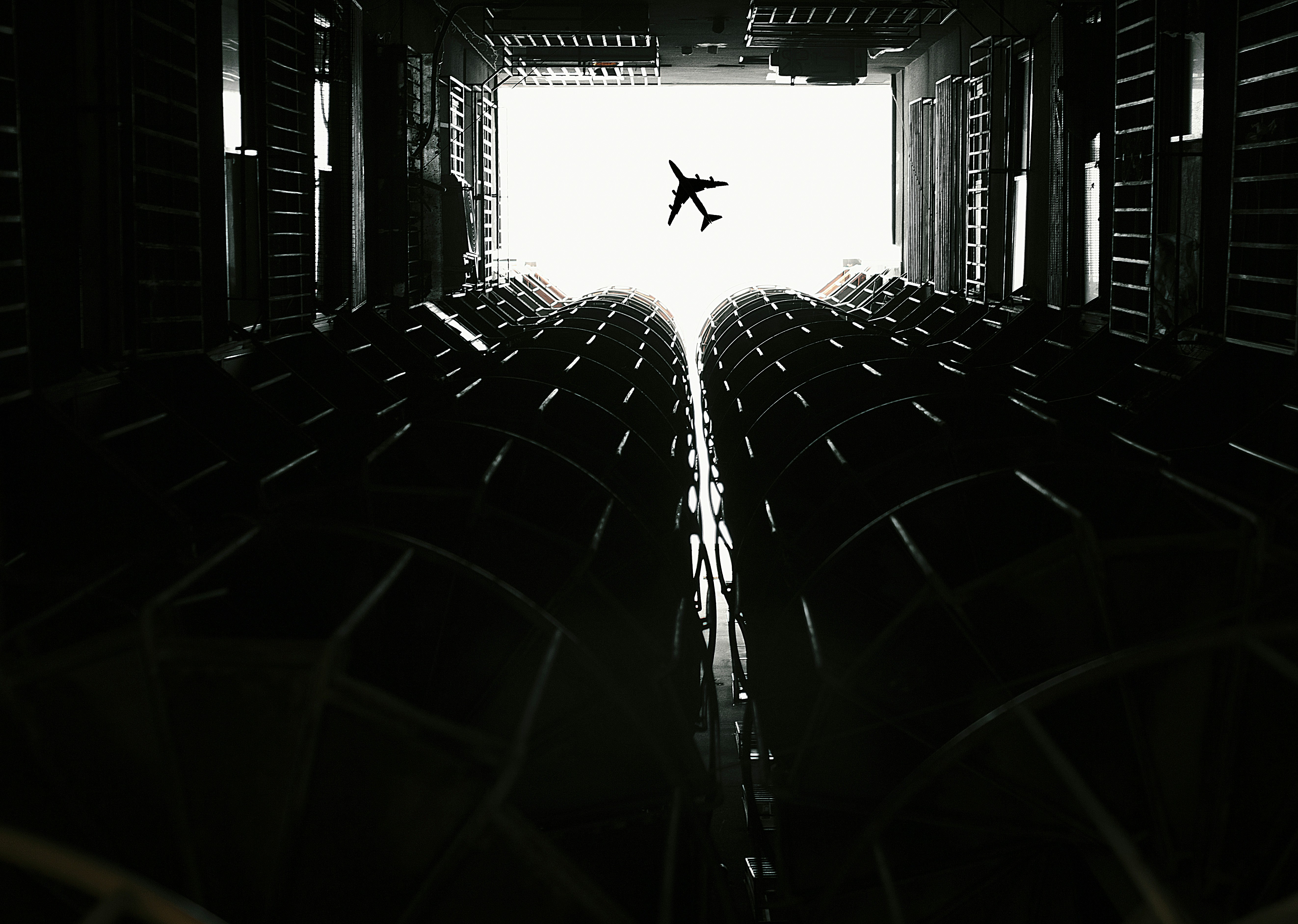 Jet through the Light: A Lone Plane Between Shadowed Rows