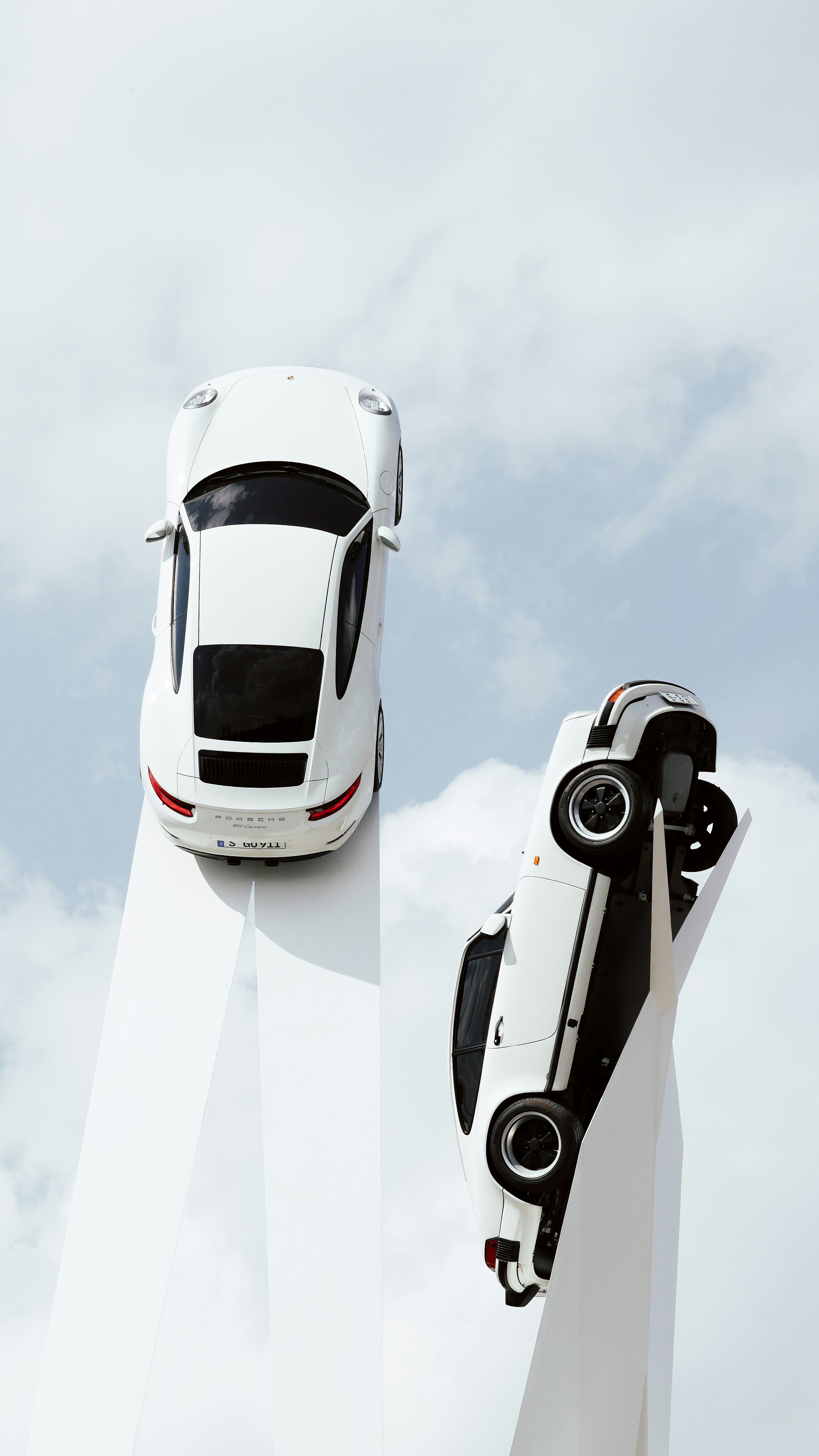 A white car and a black car on top of each other photo – Free Stuttgart ...