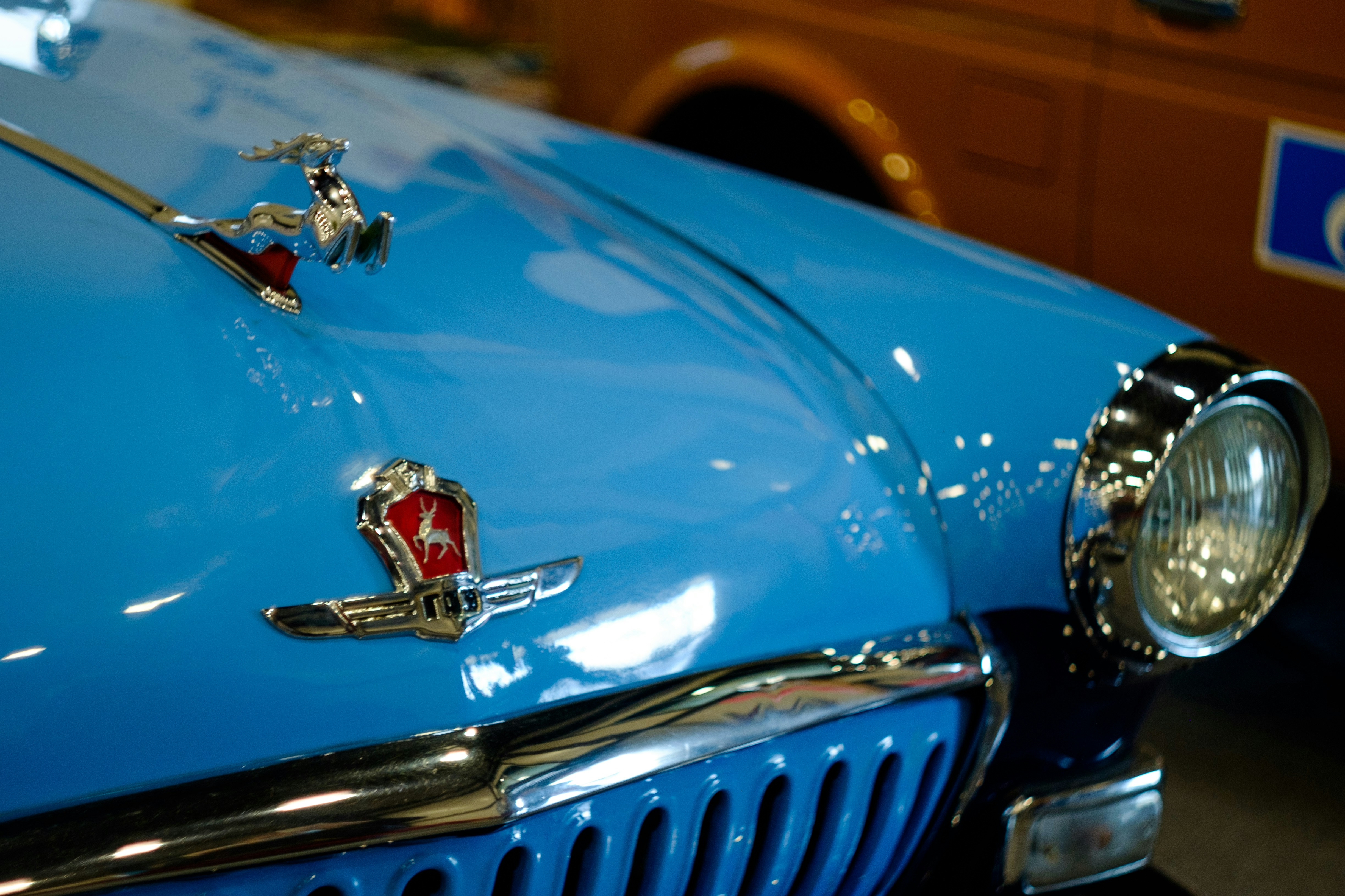 Azure Chrome Nostalgia: Close-Up of a Vintage Hood Emblem