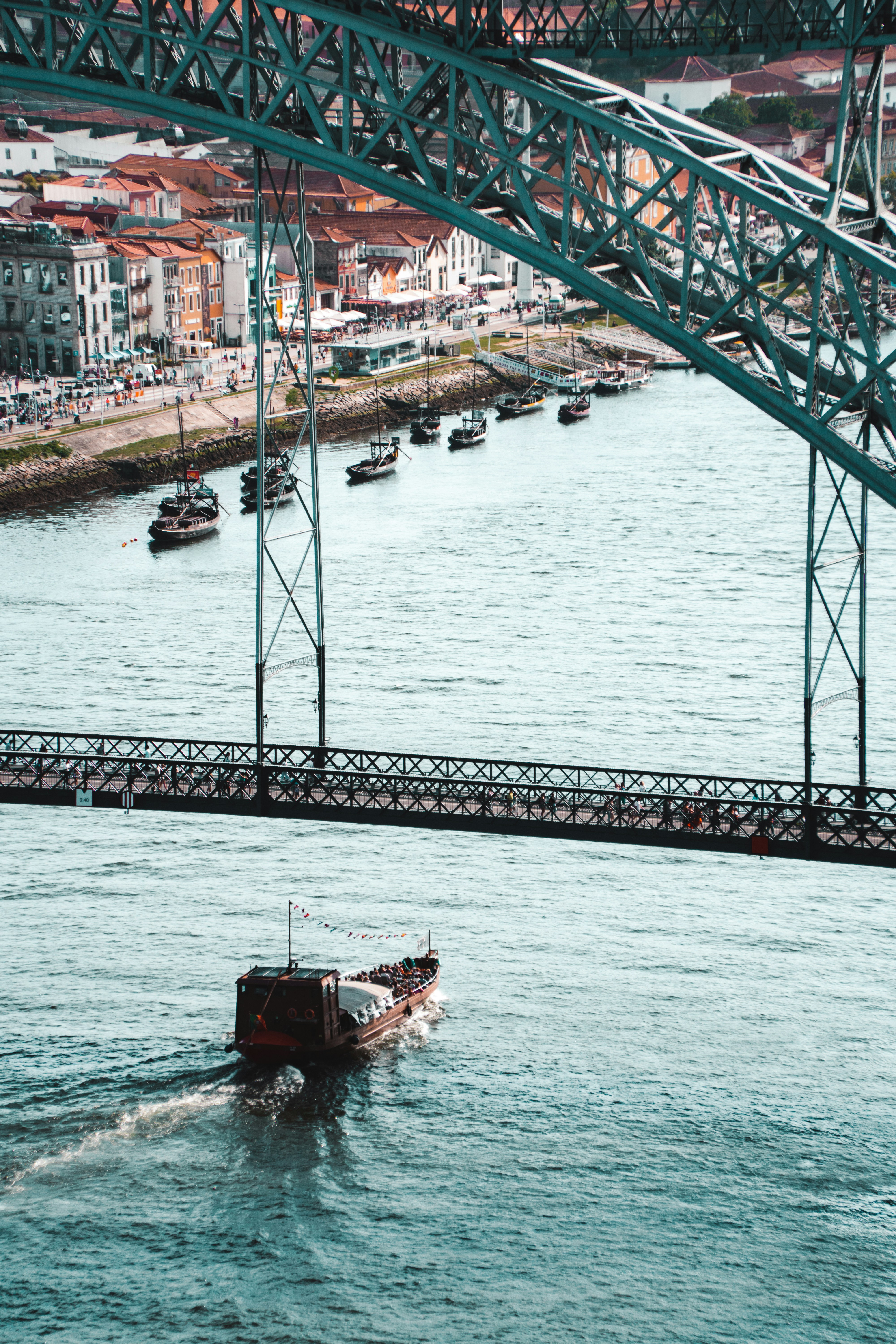 Under Porto's Iron Arch: A Riverboat Glides Along the Douro