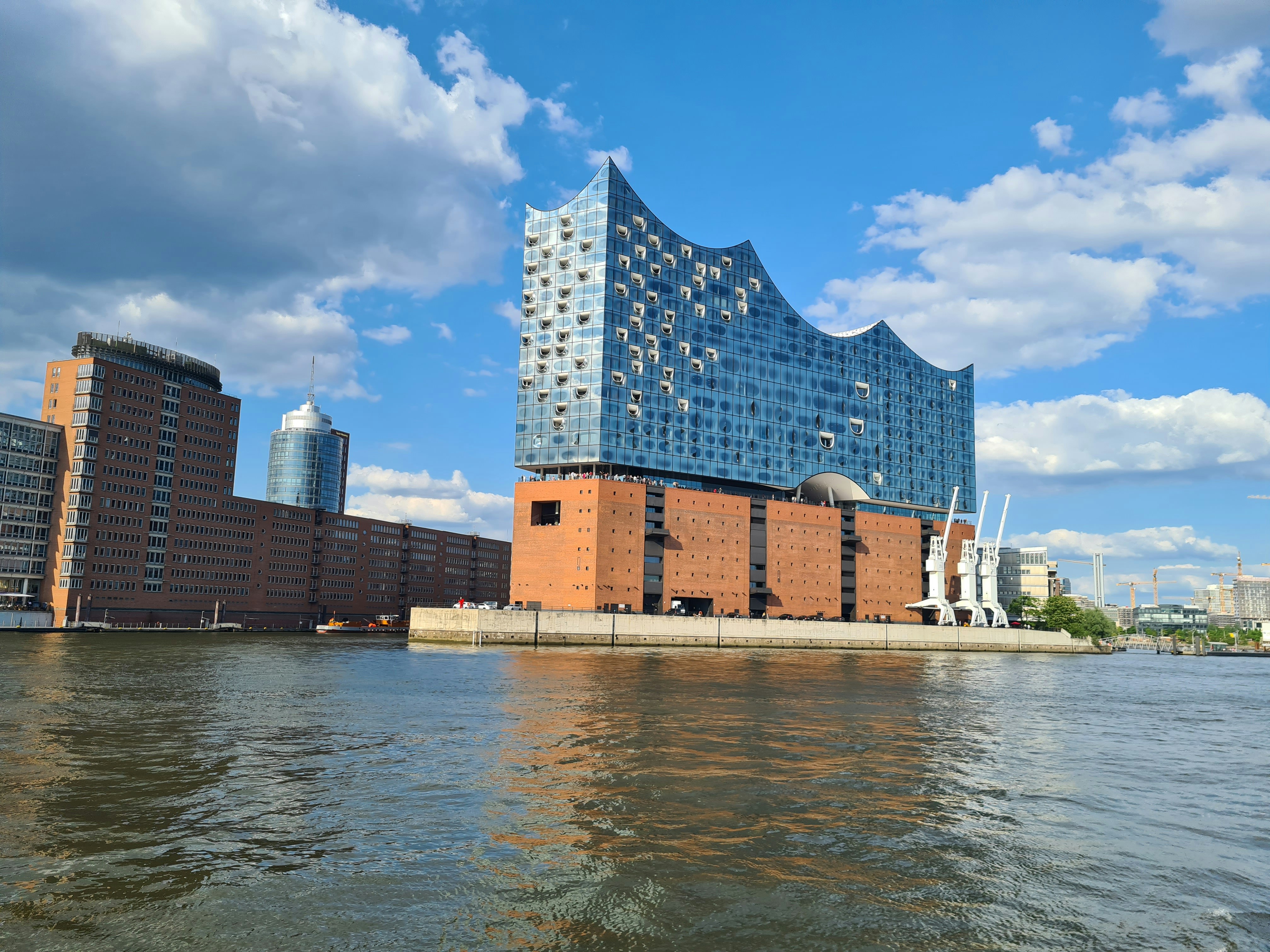 A large building sitting on top of a river next to tall buildings photo ...
