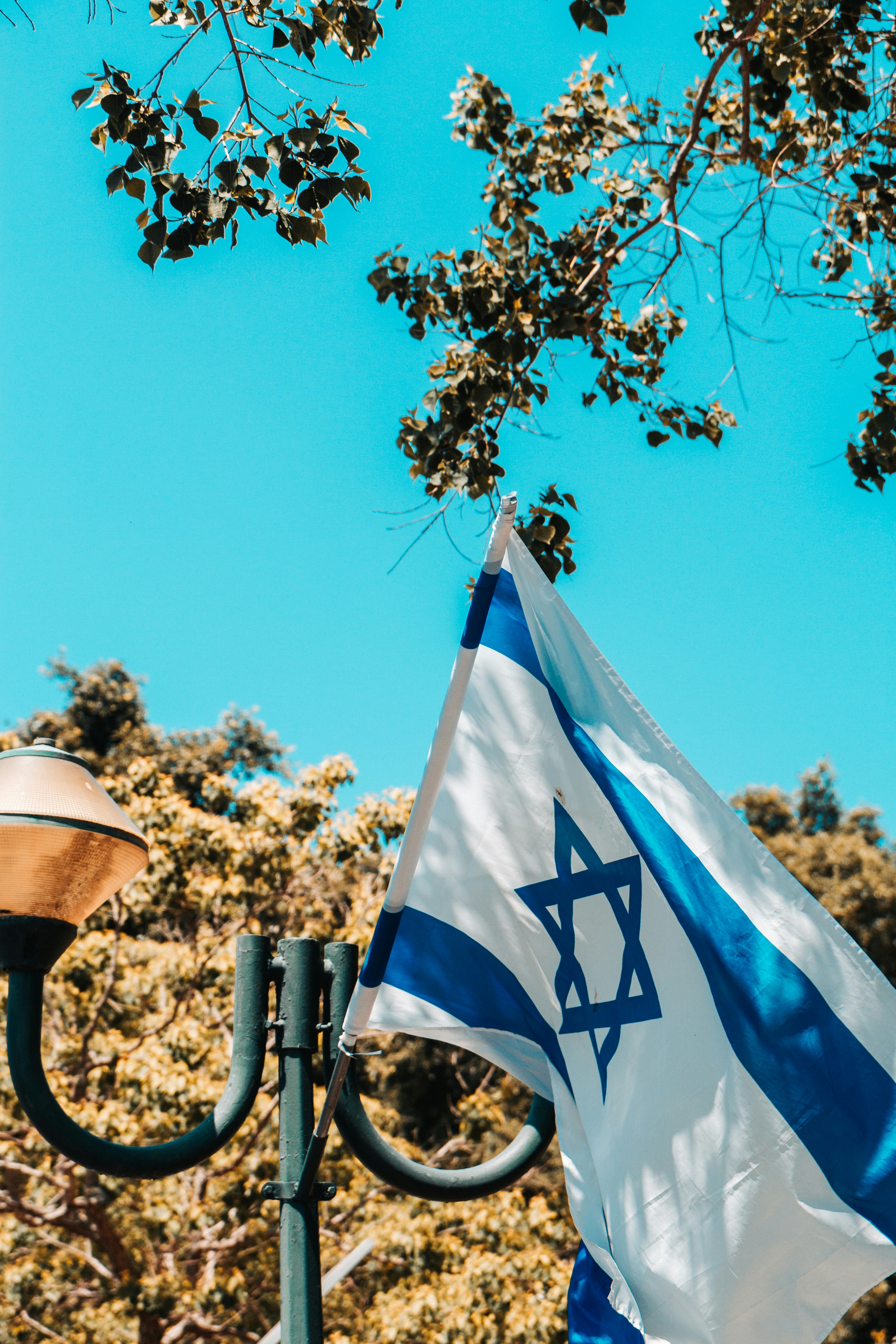 The israeli flag is flying in the wind photo – Free Israel Image on ...