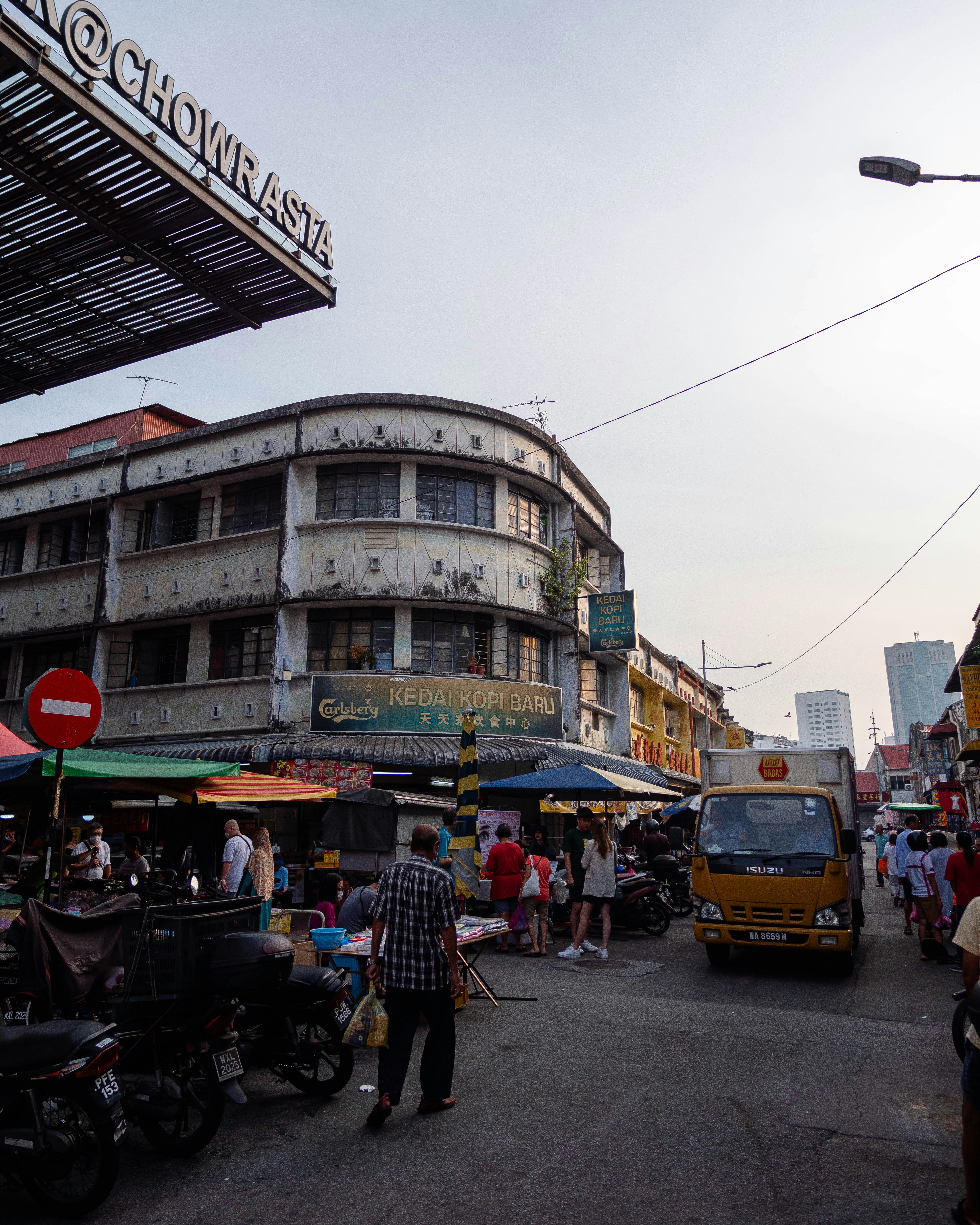 A group of people walking around a busy street photo – Free Food ...