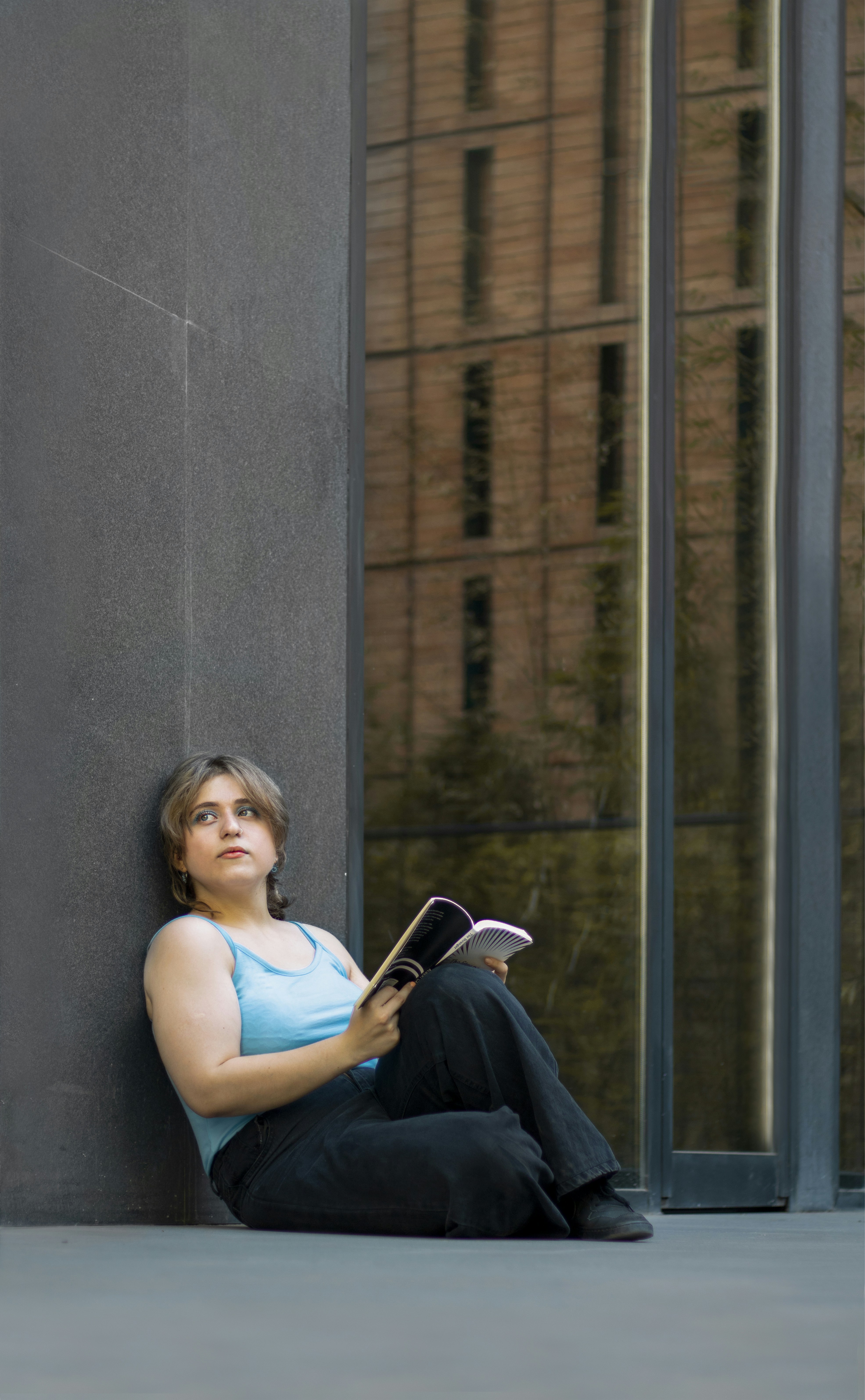 Paused by the Glass Facade: A Reader's Quiet Moment