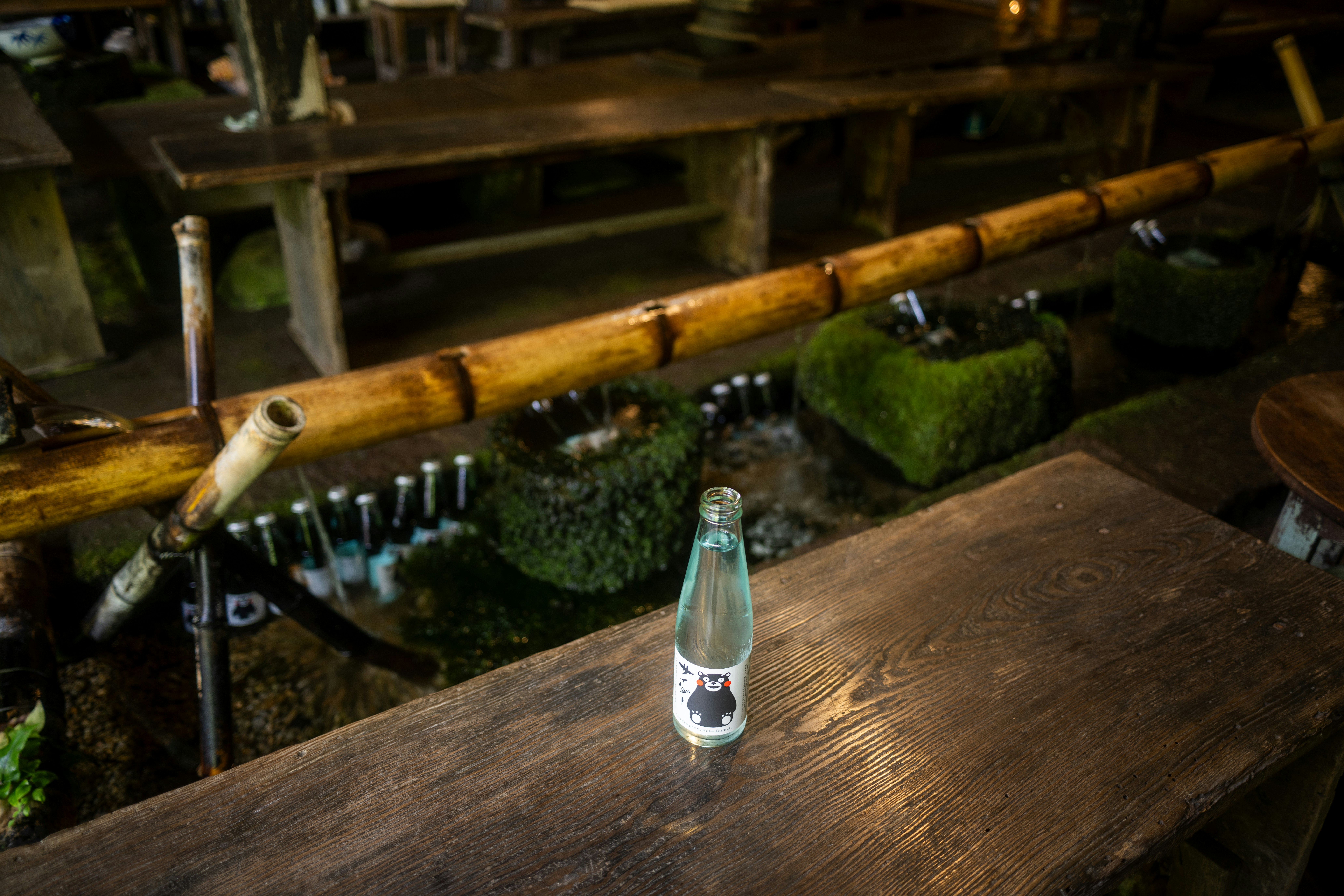 Lone Bottle on a Weathered Table in a Lantern-lit Courtyard