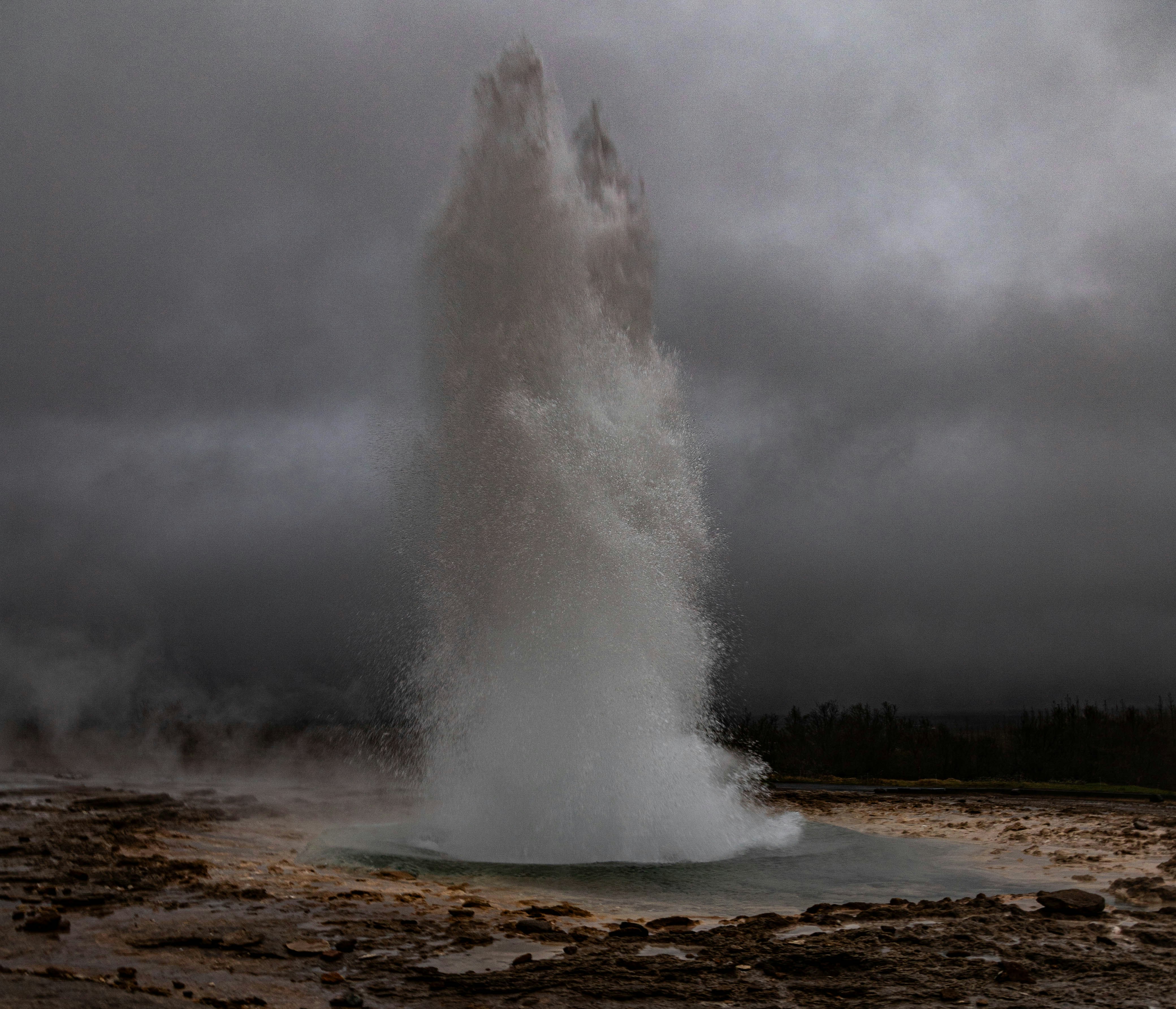 A geyser spewing out water into the air photo – Free Geysir Image on ...
