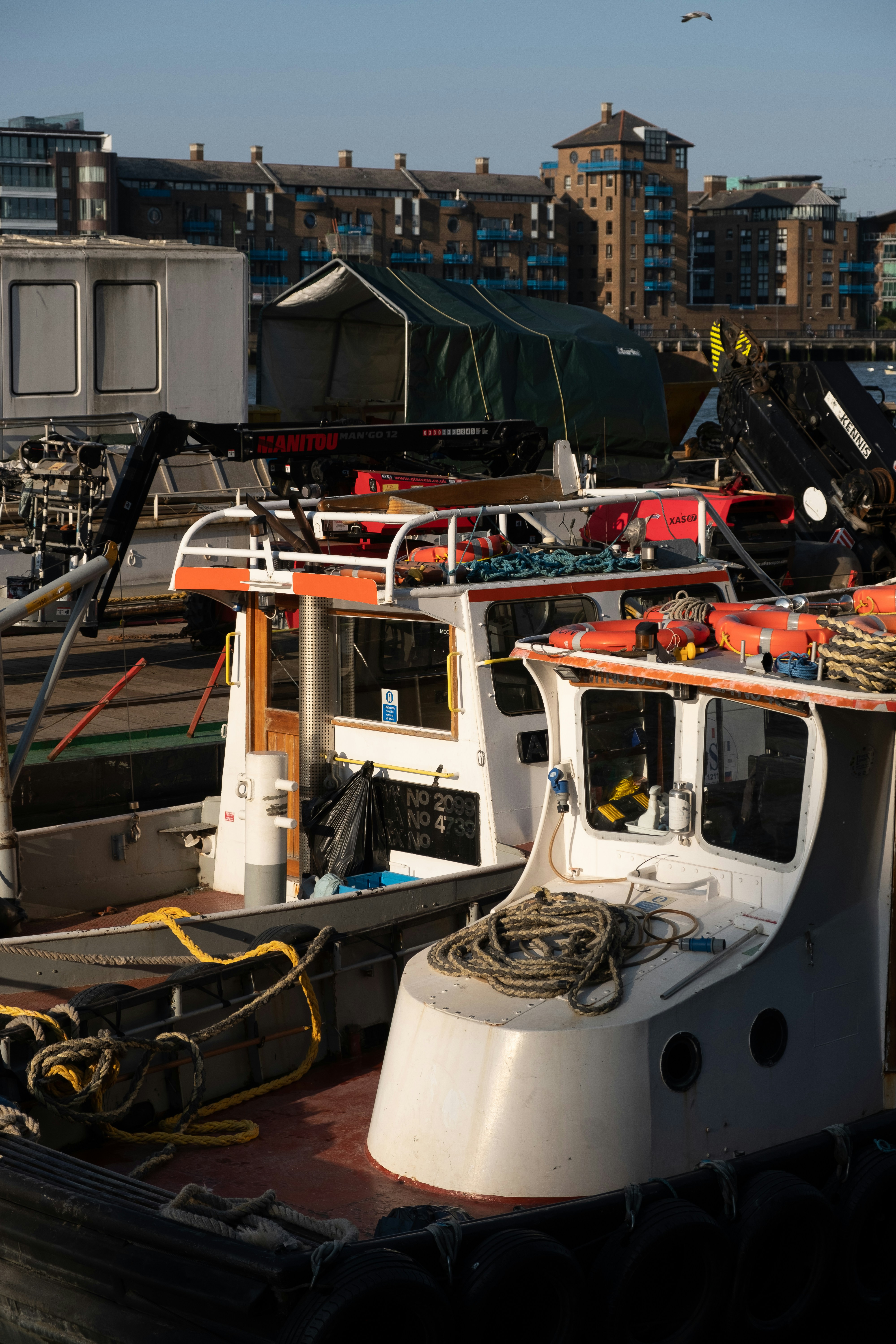 White Tug amid a Tangled Web of Ropes at a Busy Harbor