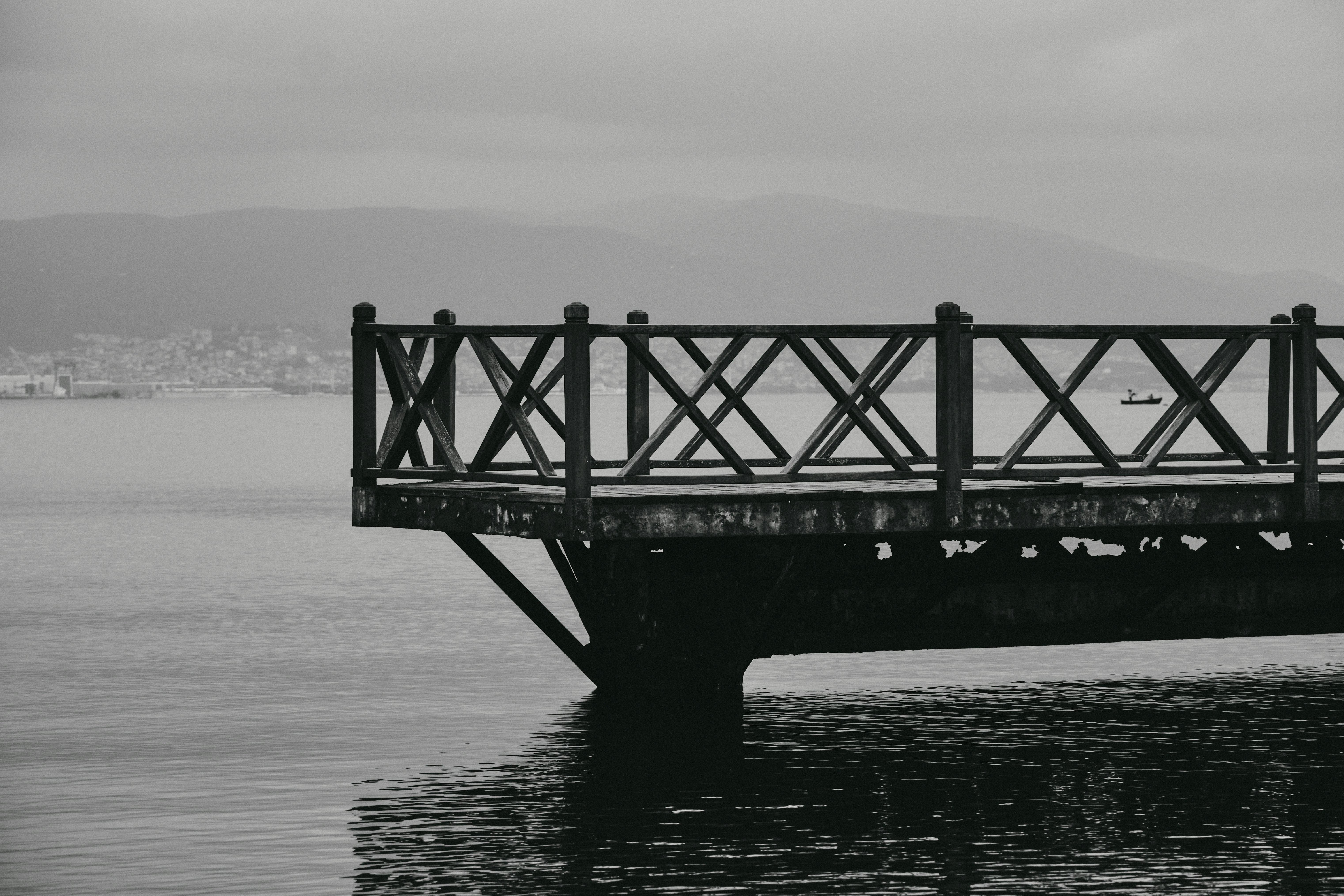 Crosshatched Pier Over a Tranquil Monochrome Sea
