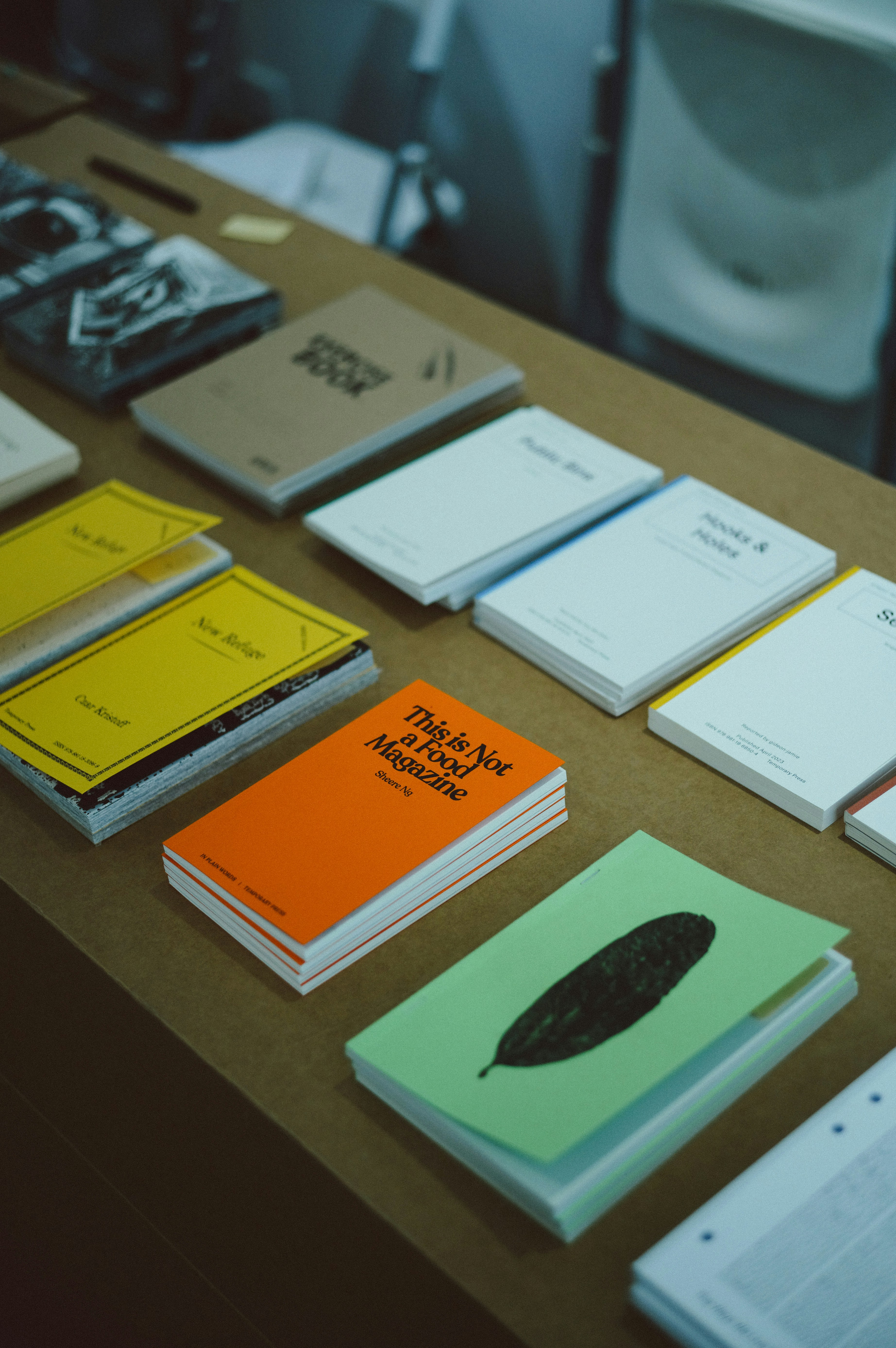 A table topped with lots of notebooks next to a toilet photo – Free ...