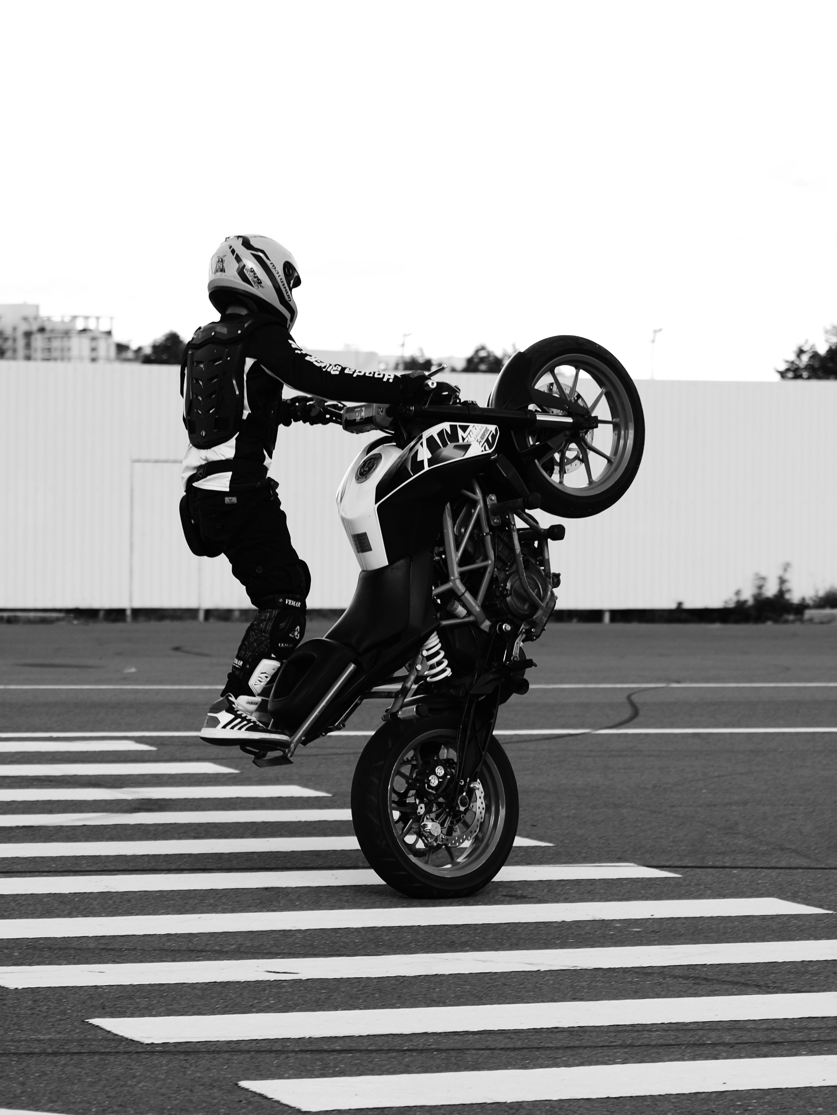 A person on a motorcycle doing a trick photo – Free Man Image on Unsplash