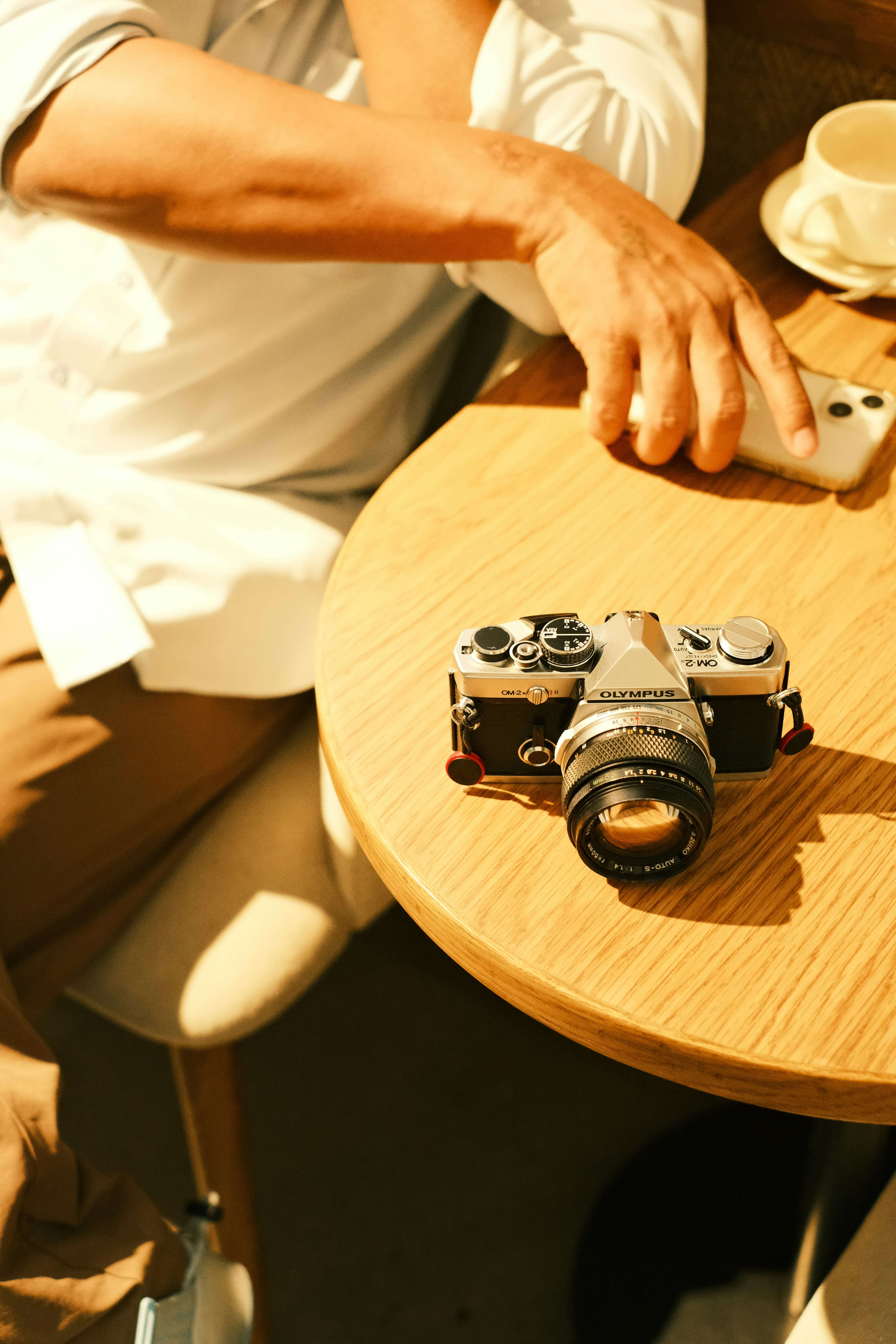Sunlit Tabletop Moment: A Vintage Olympus Holds Court