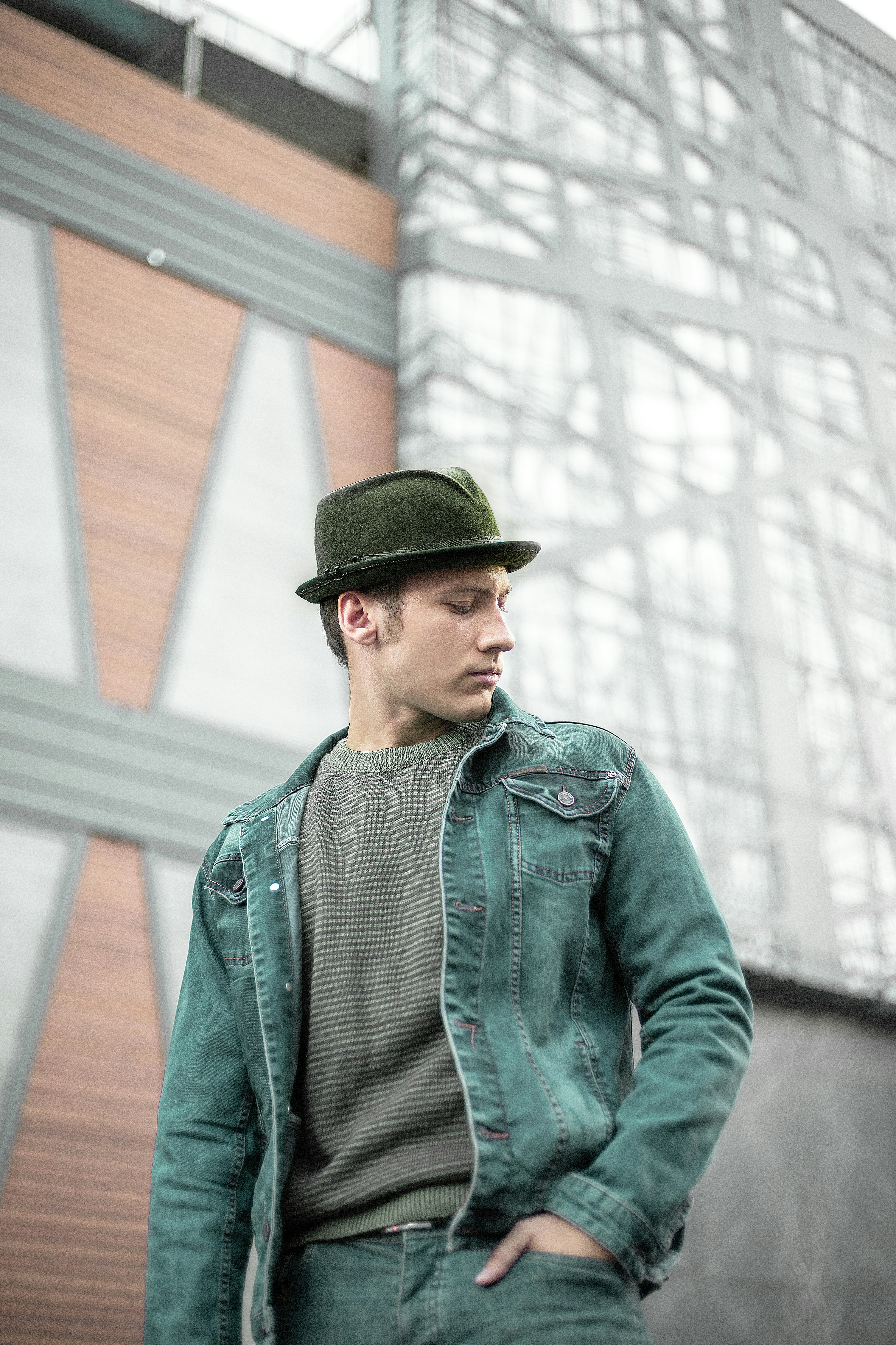 Green Hat, Concrete Lines: A Quiet Portrait in Urban Light